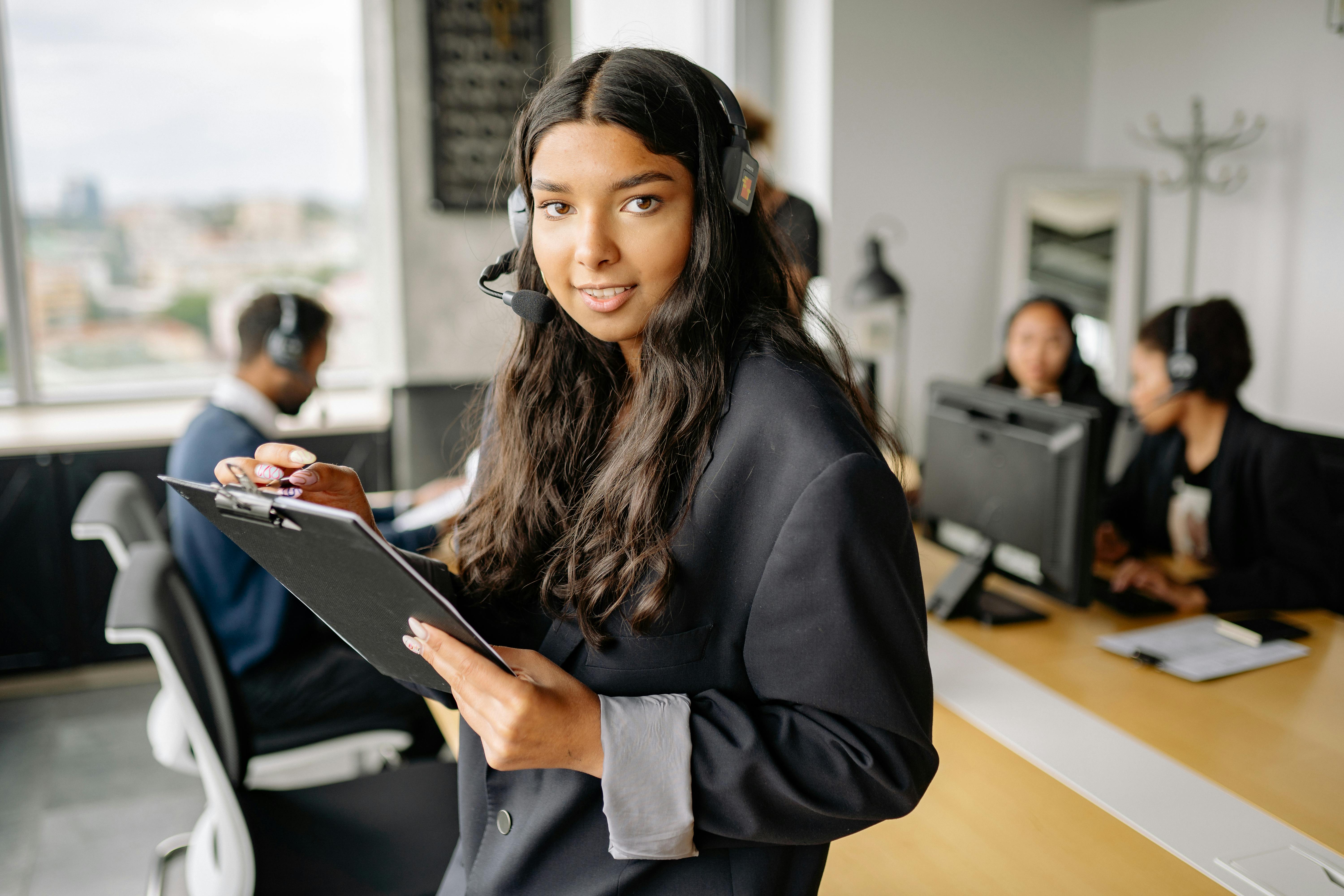 A Woman Writing on Her Computer Desk · Free Stock Photo
