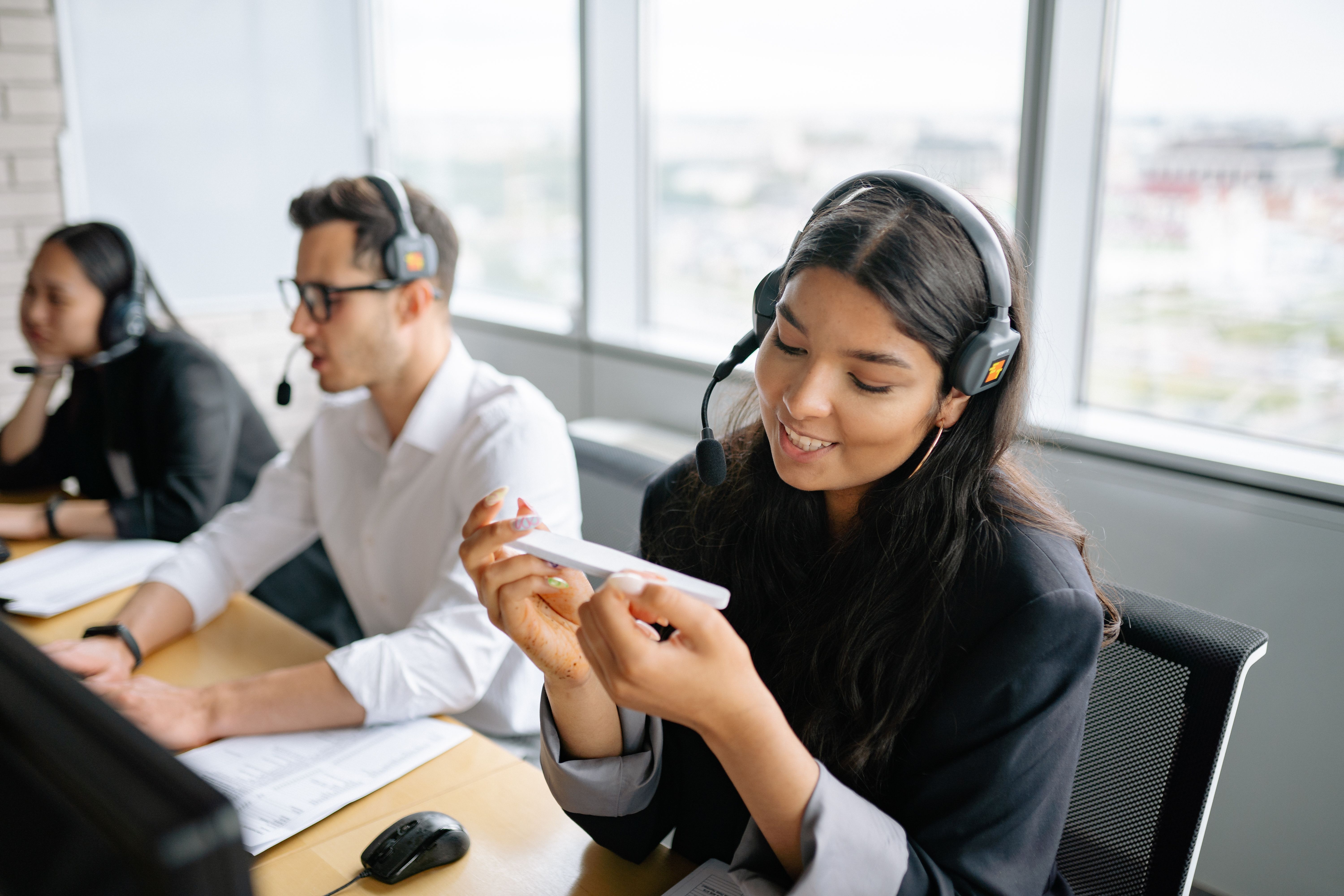 A Smiling Woman Working in a Call Center while Looking at Camera · Free ...
