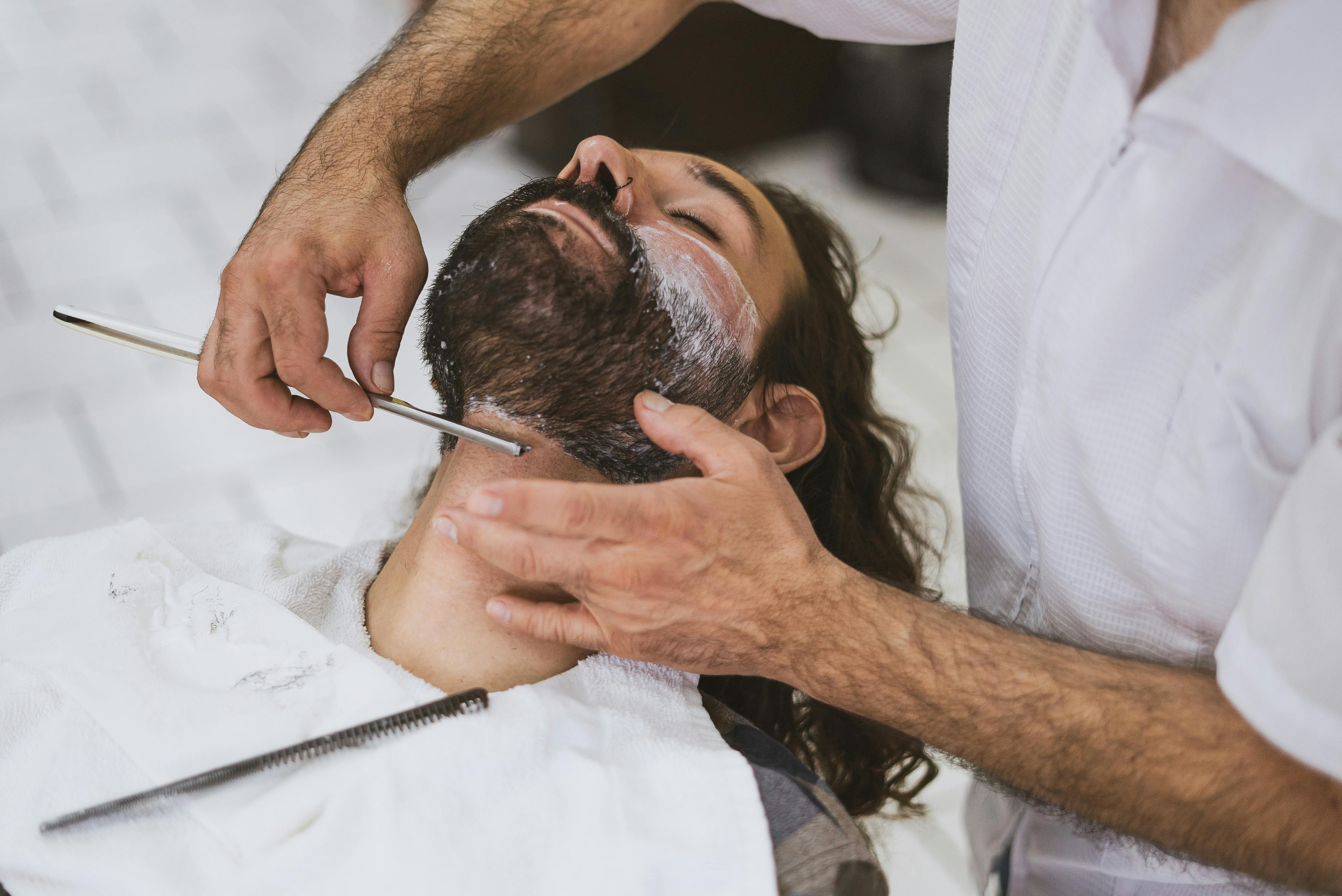 Photo of a Man Getting His Beard Shaved · Free Stock Photo