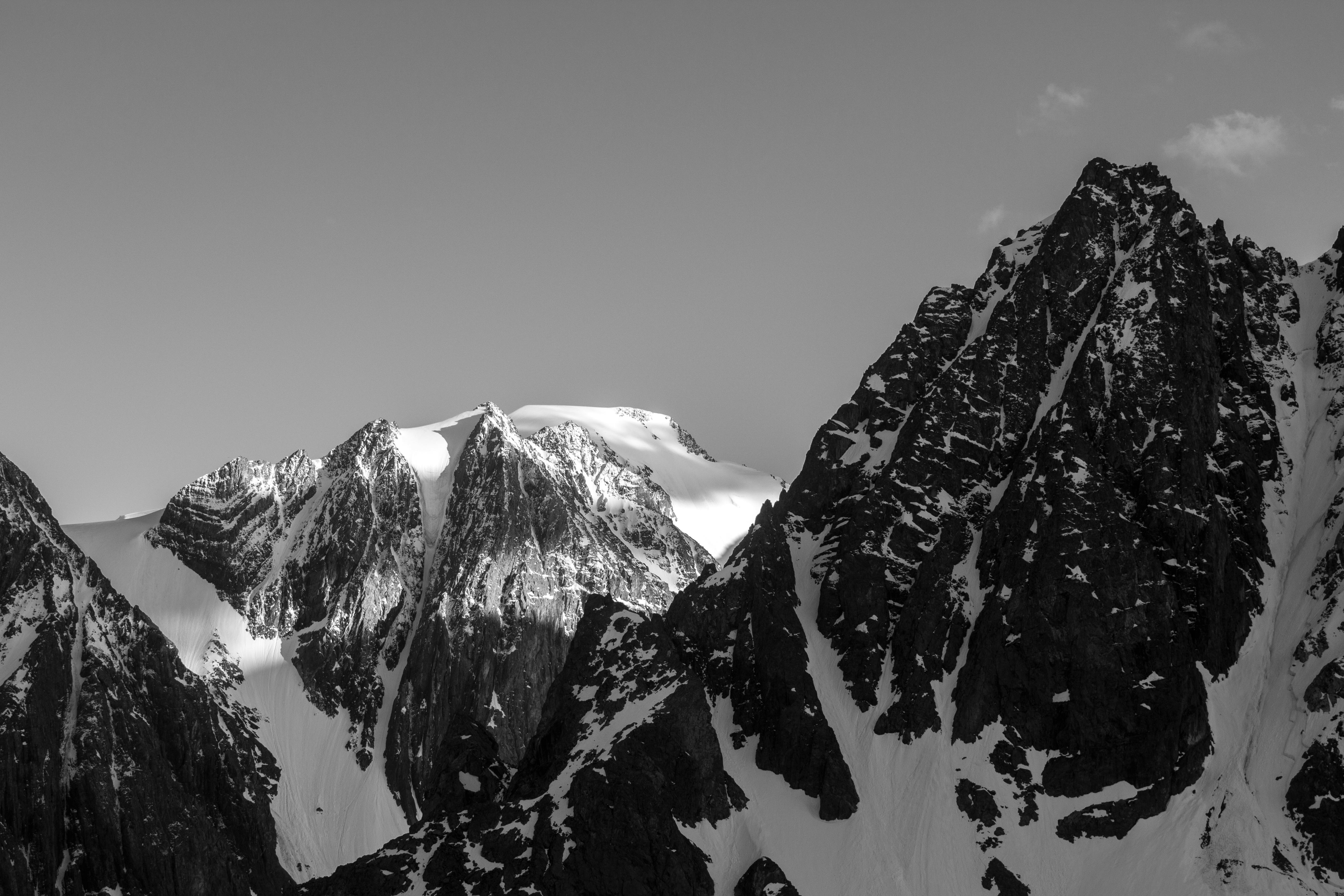 Grayscale Photo of Snow Covered Mountains · Free Stock Photo