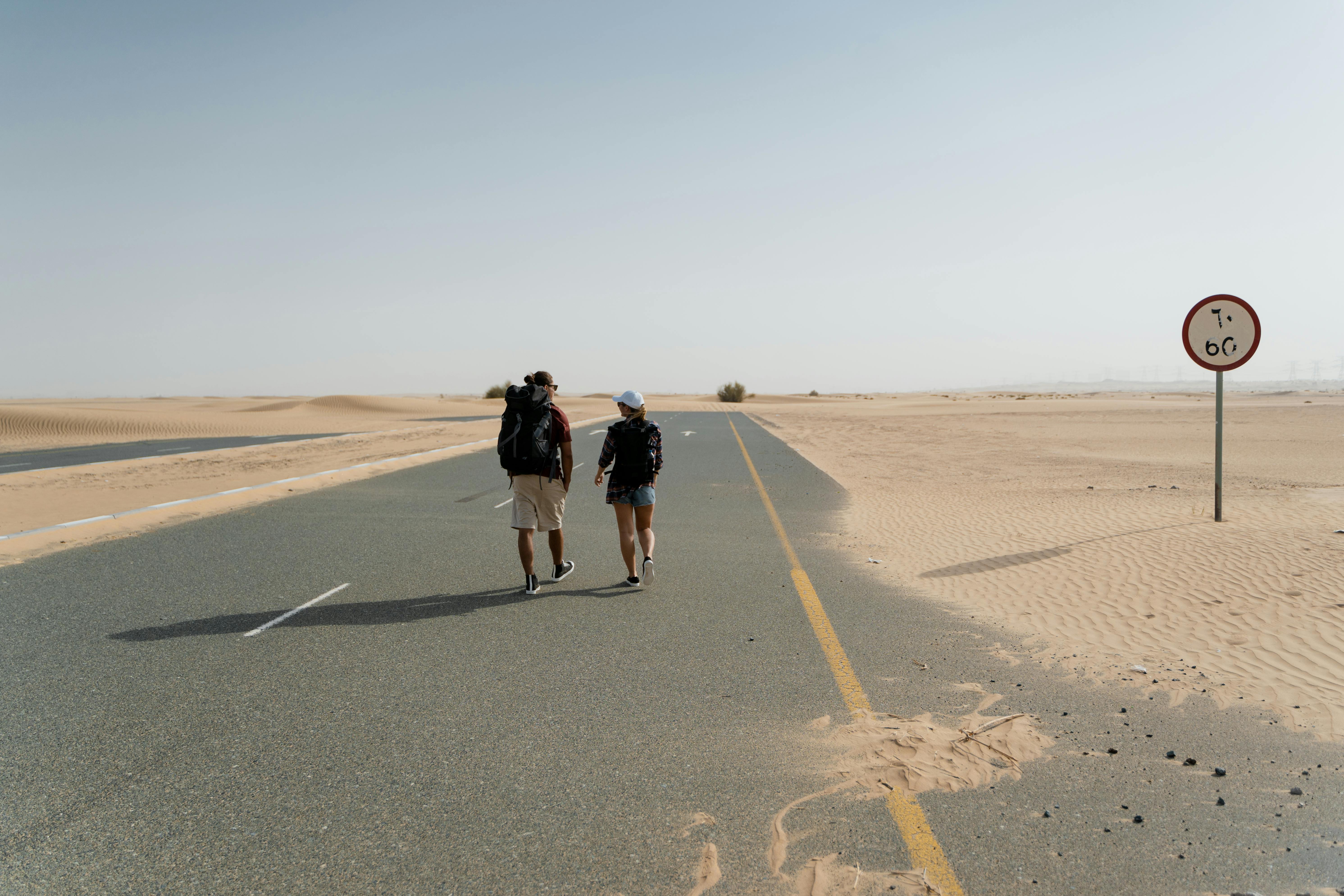 Two People Walking on the Road · Free Stock Photo