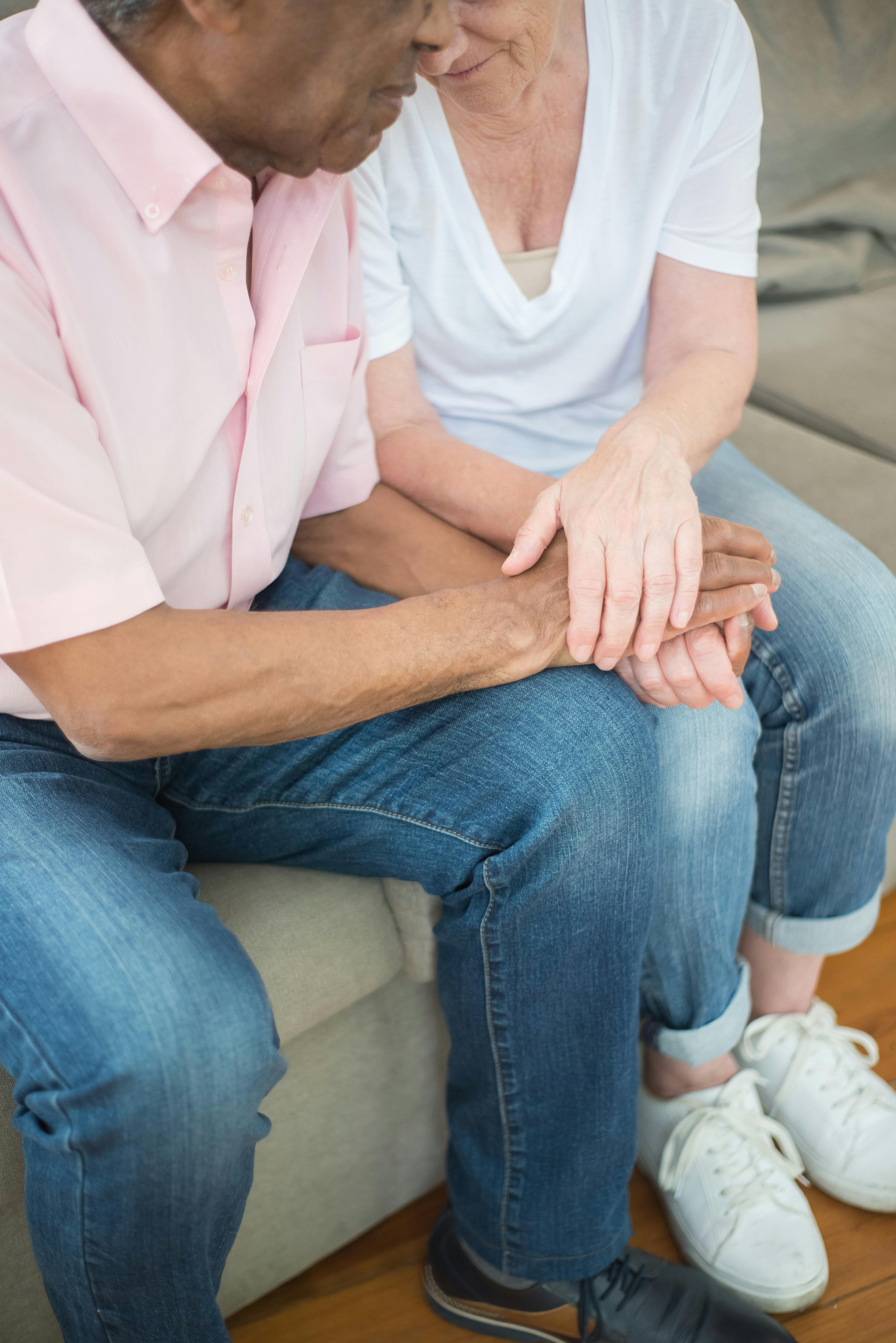 People Holding Hands while Sitting on a Couch · Free Stock Photo