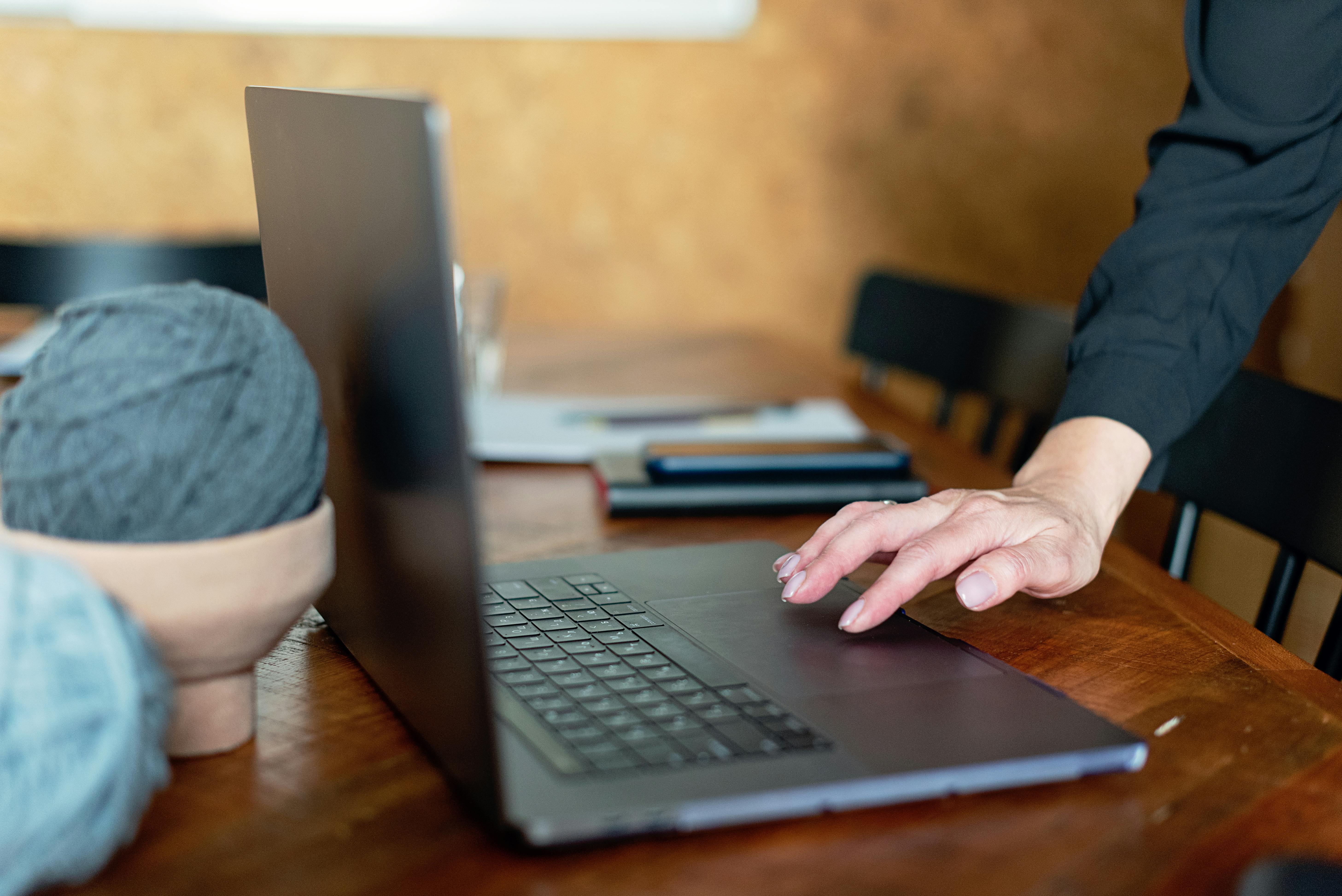Person Browsing the Internet by Using a Laptop · Free Stock Photo