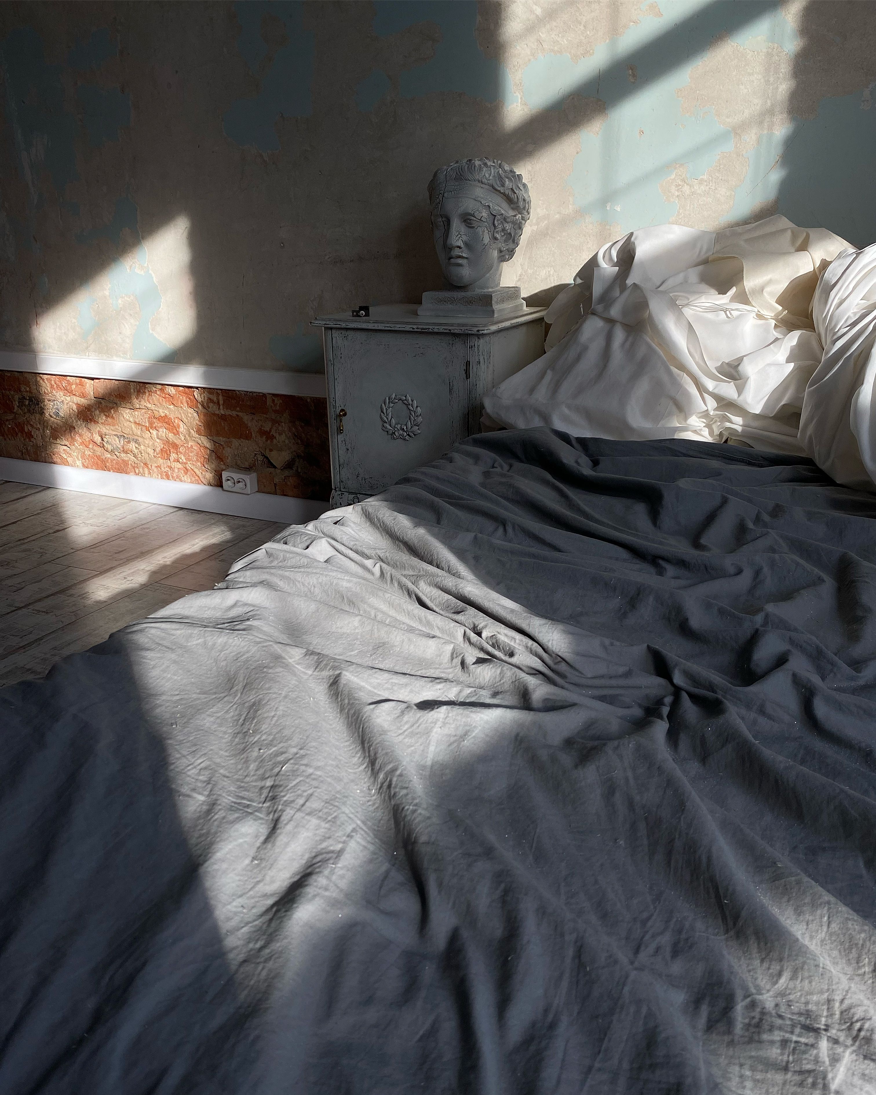 Photo of a Sculpture Beside a Bed · Free Stock Photo