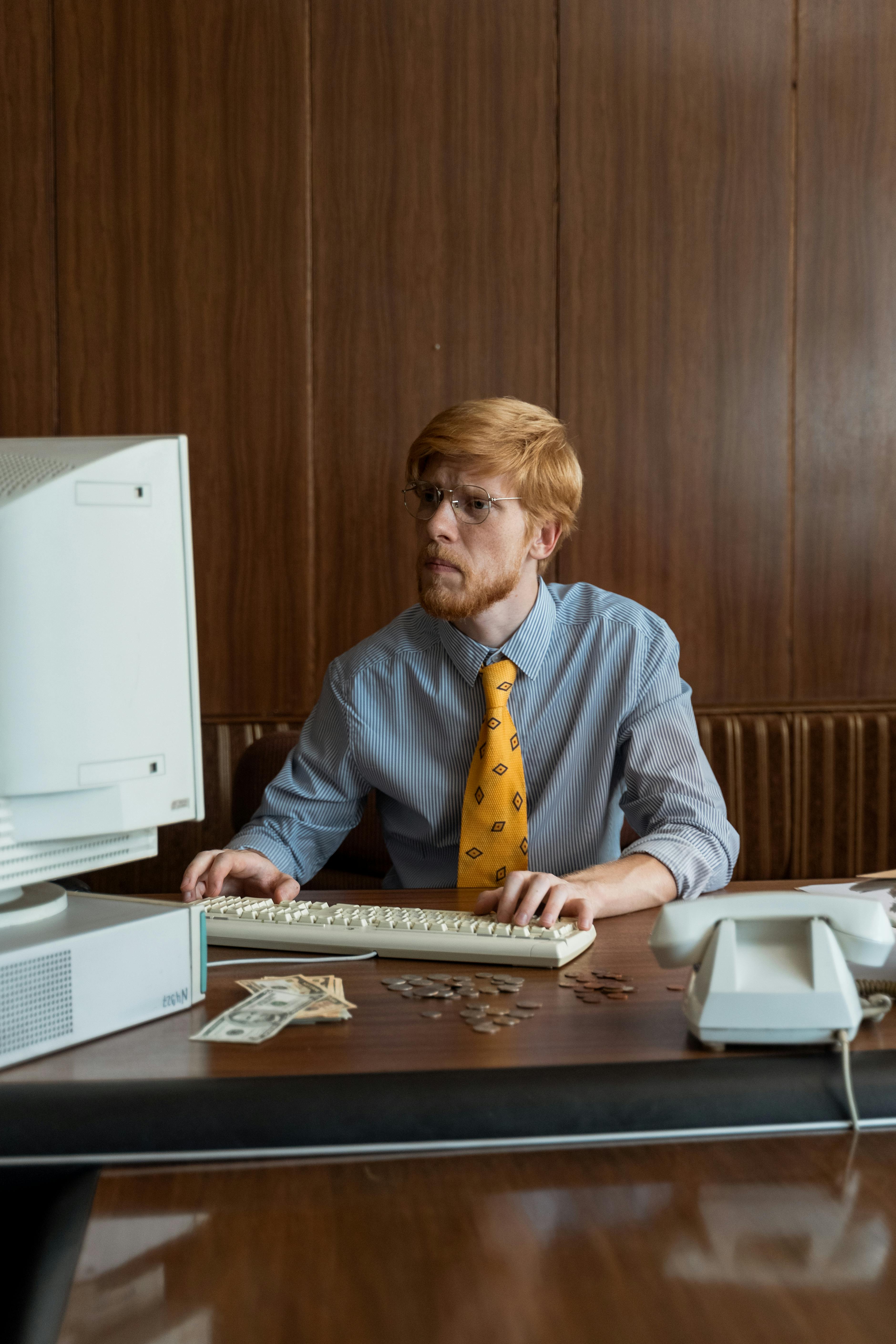 A Businessman Staring at His Computer Monitor · Free Stock Photo