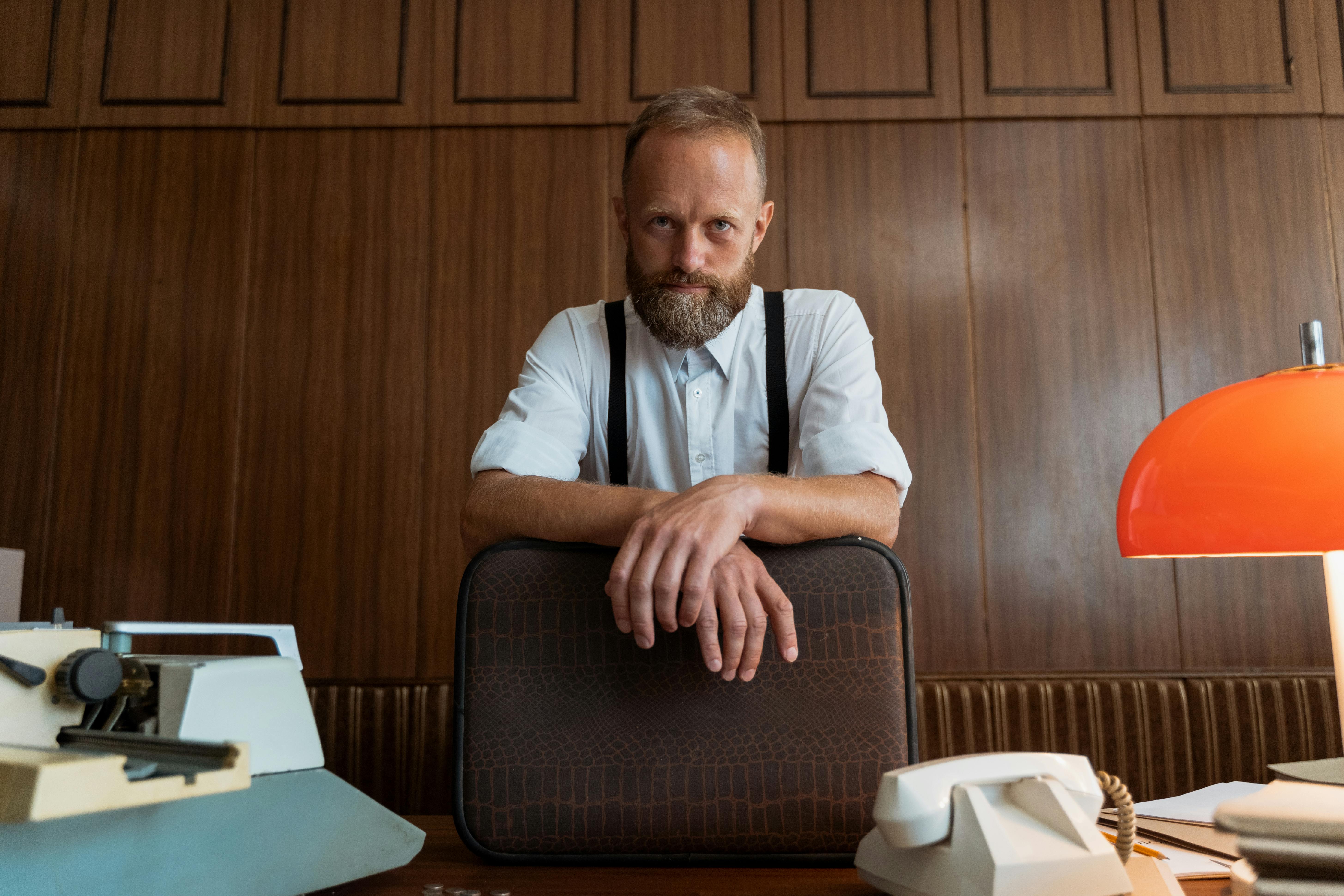 A Man Standing at his Work Desk · Free Stock Photo