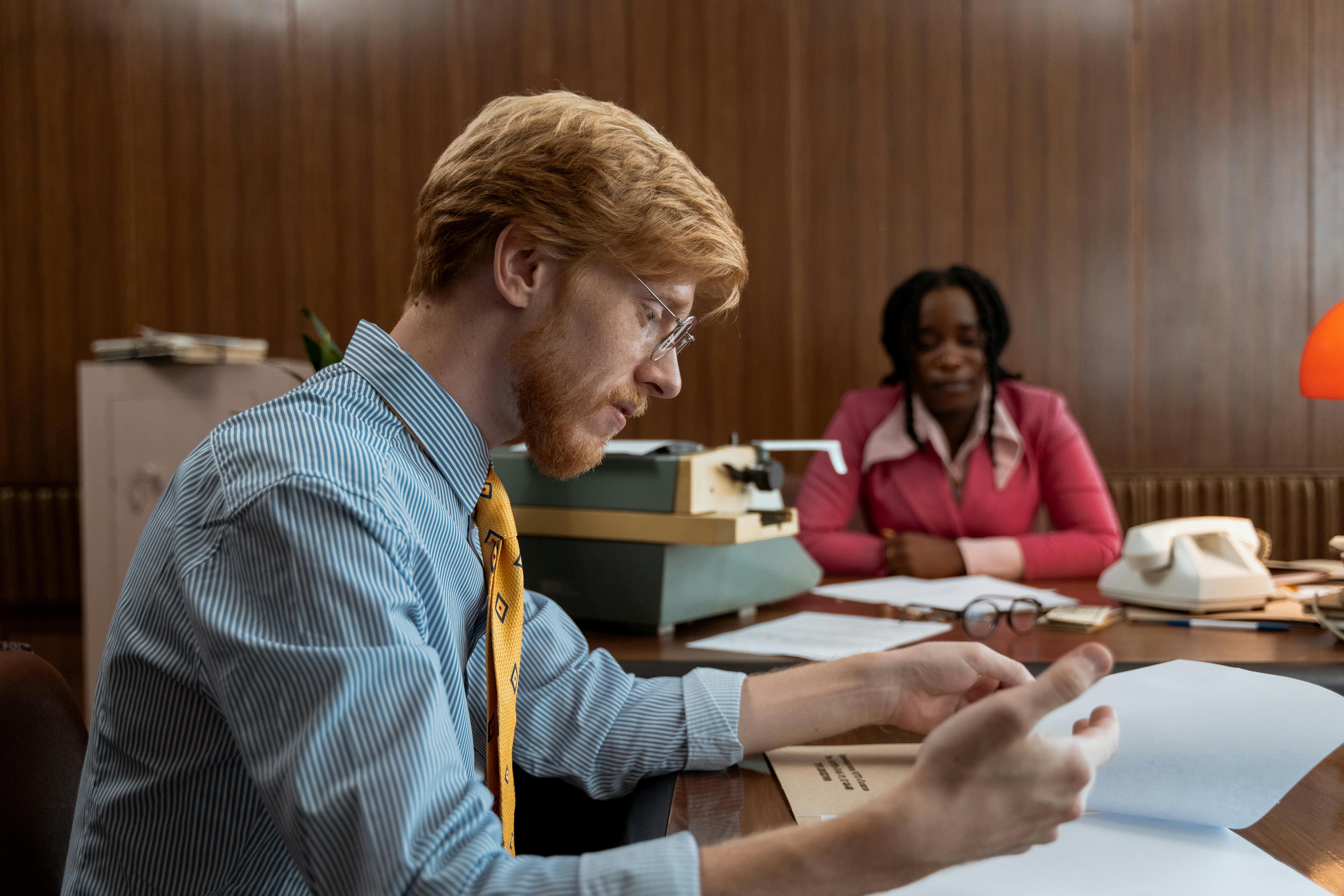 A Man Looking Reading a File at an Office · Free Stock Photo
