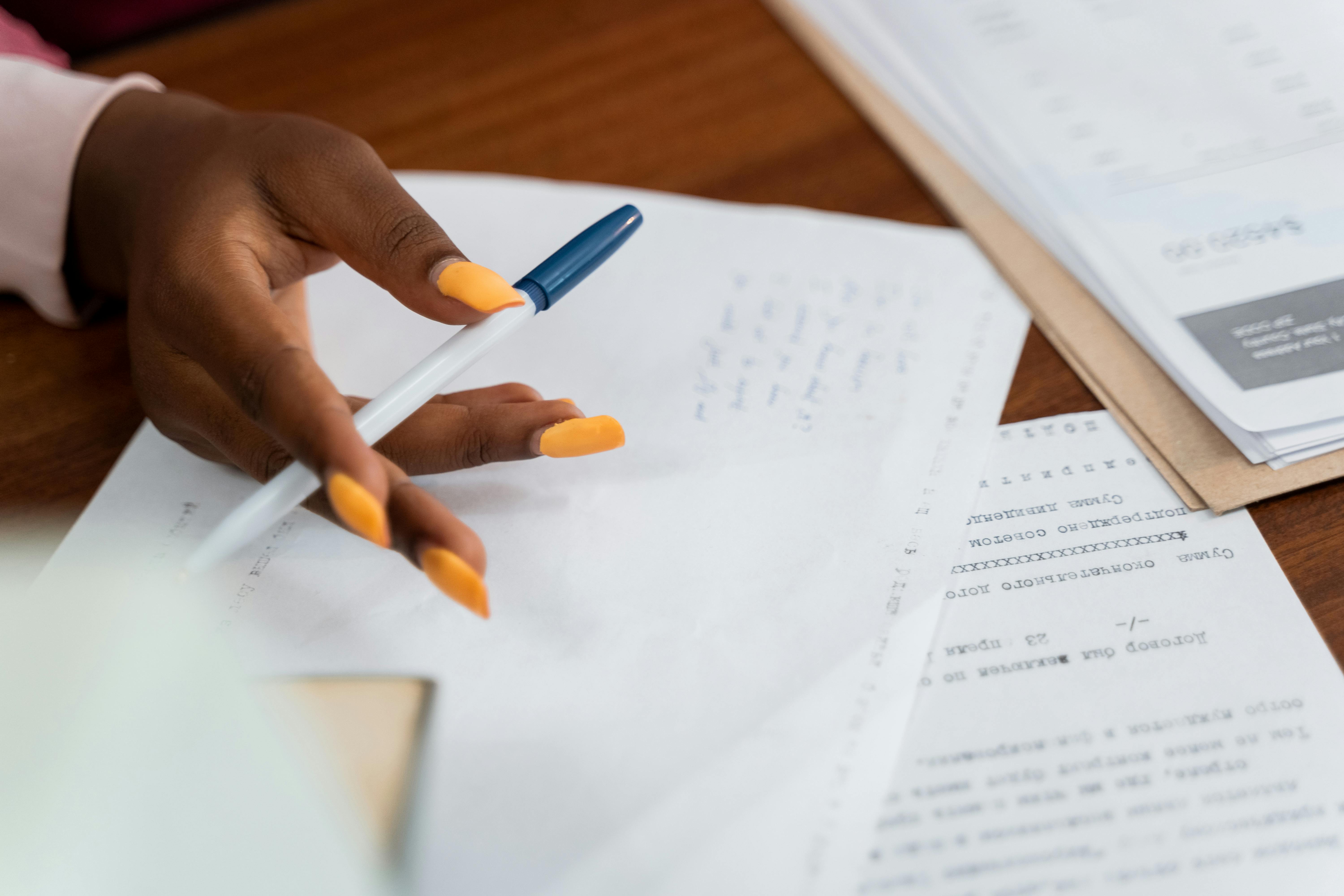 A Person Holding a Pen · Free Stock Photo