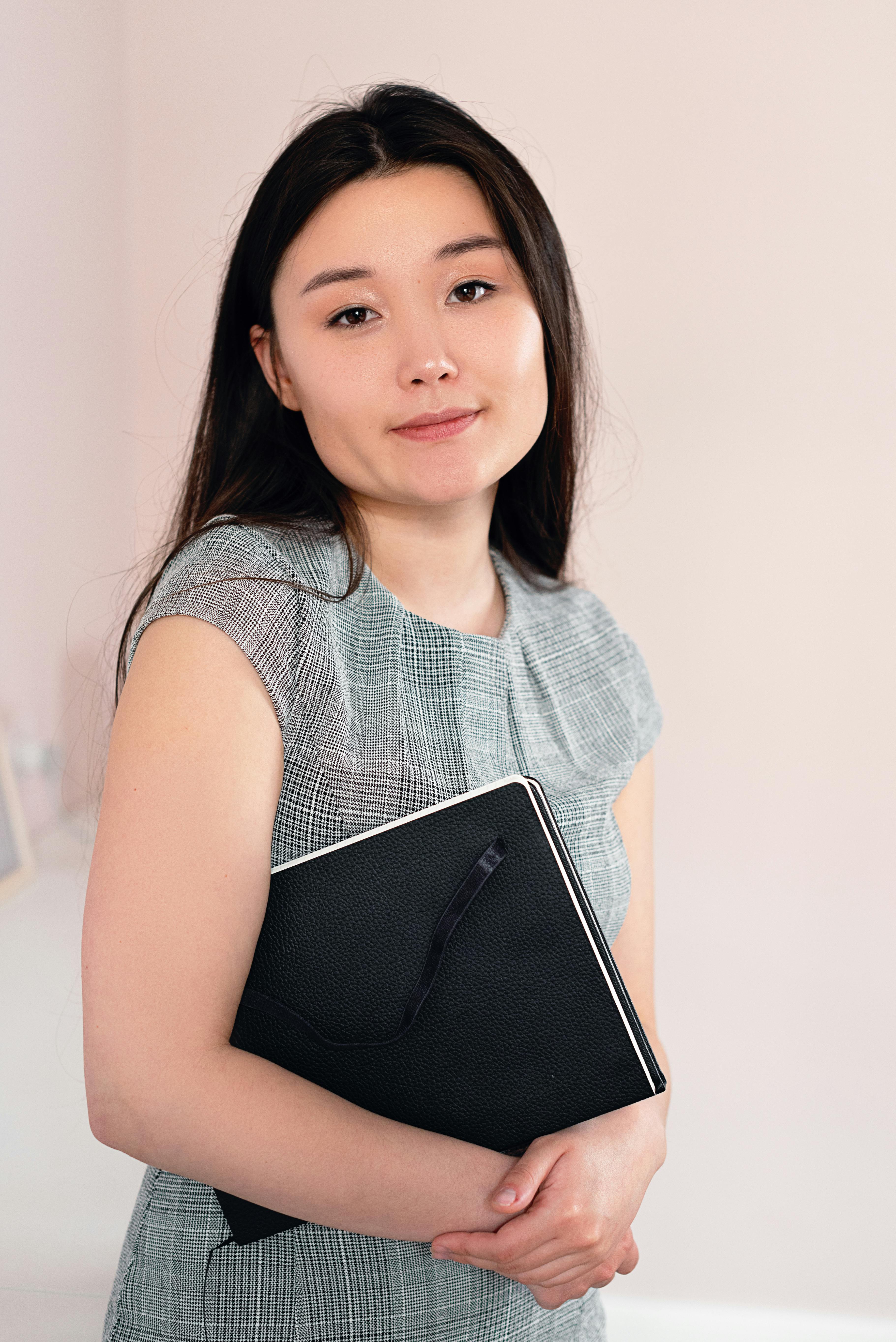 Woman Holding Her Black Notebook · Free Stock Photo