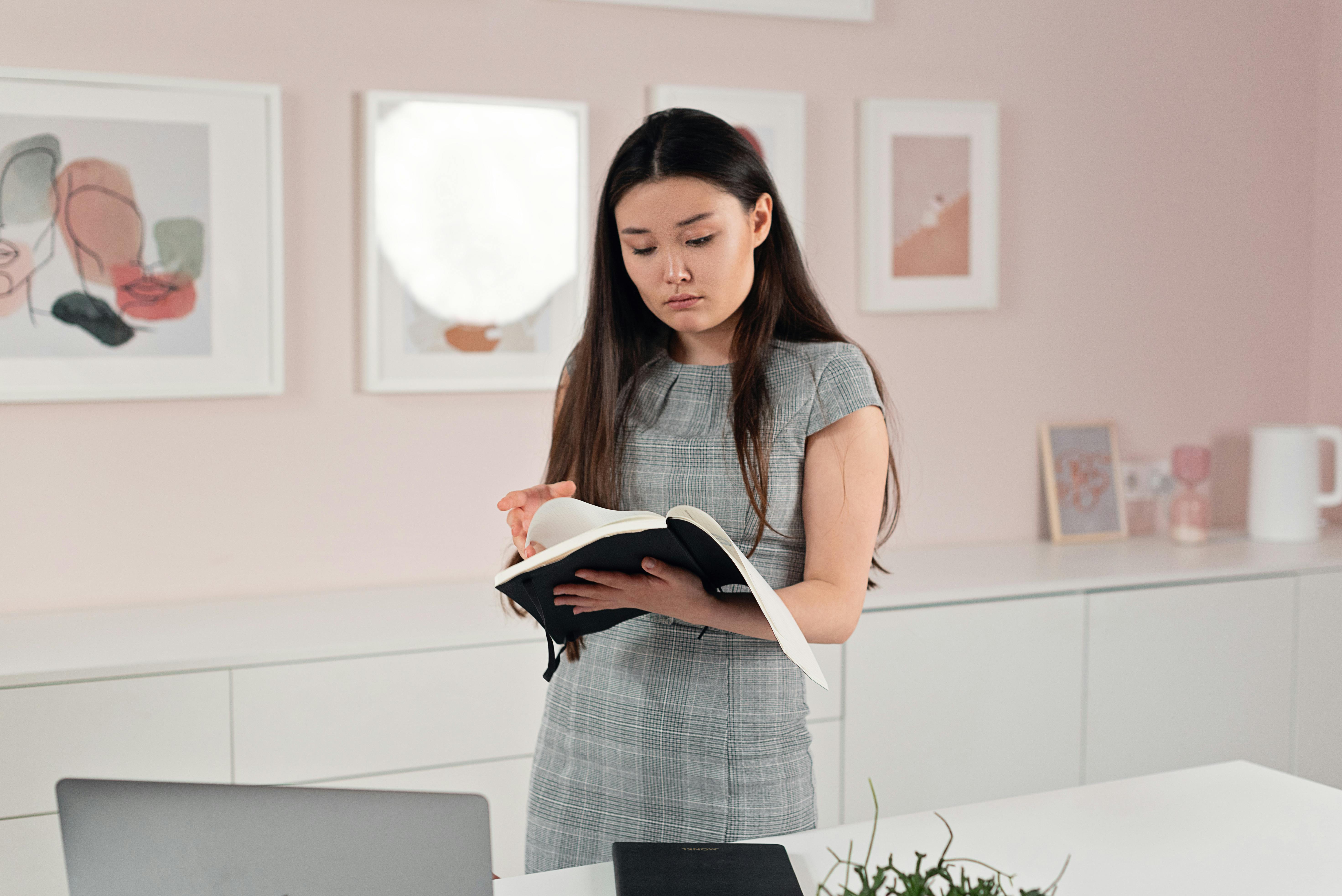 A Woman Looking in the Notebook · Free Stock Photo