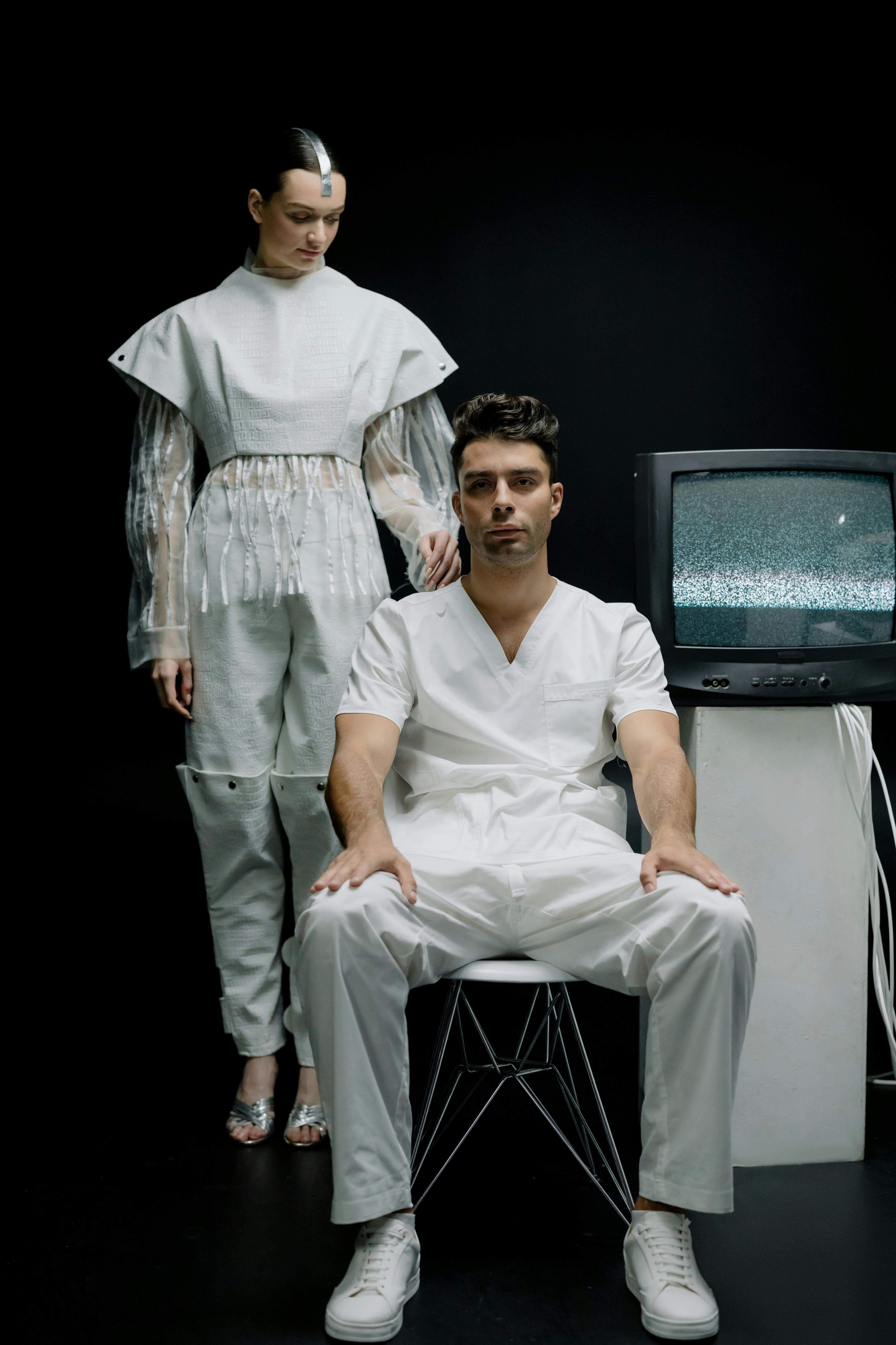 Woman Standing Behind a Man Sitting on a Chair · Free Stock Photo