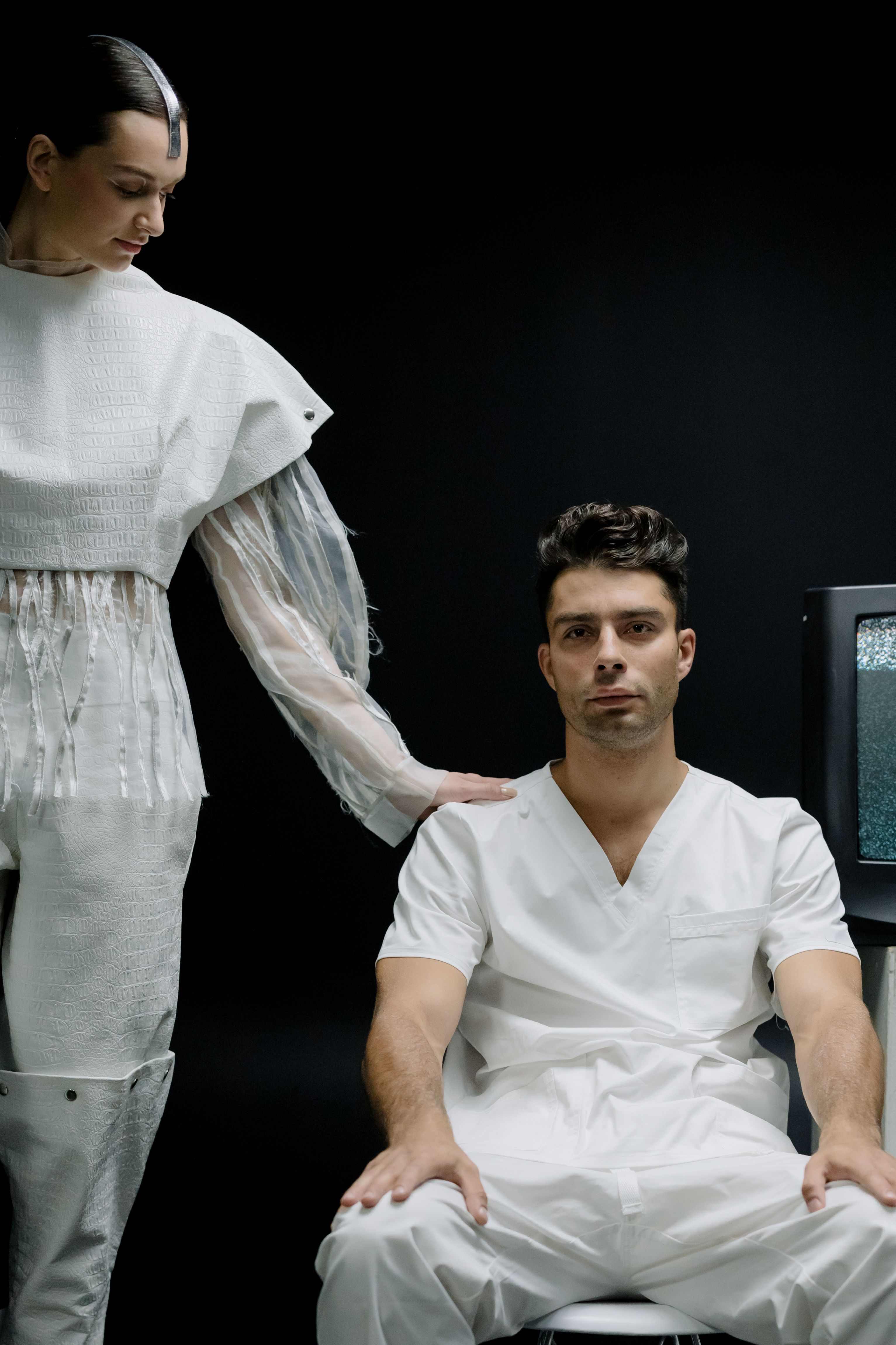 Woman Standing Behind a Man Sitting on a Chair · Free Stock Photo
