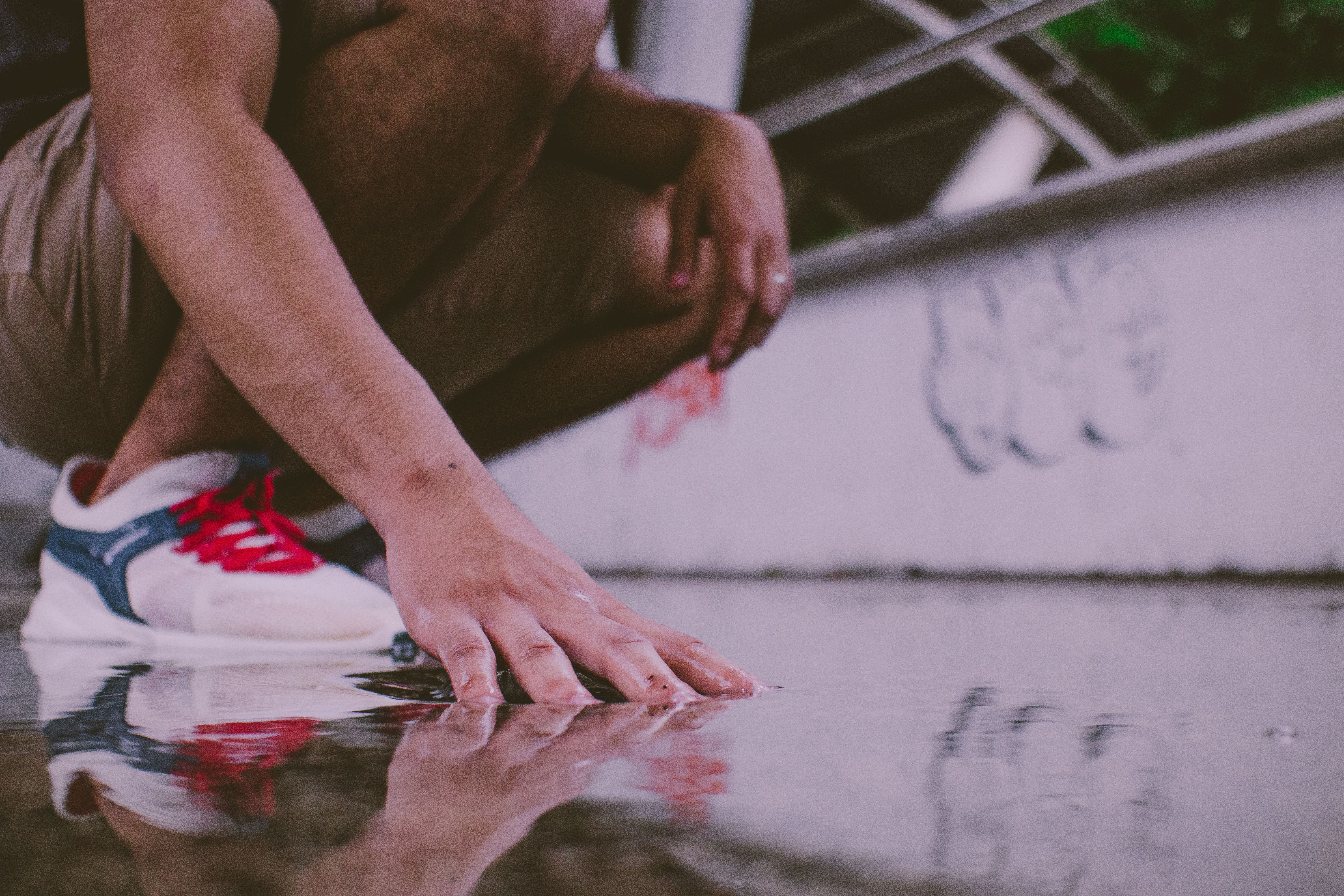 A Person Touching the Water on the Floor · Free Stock Photo