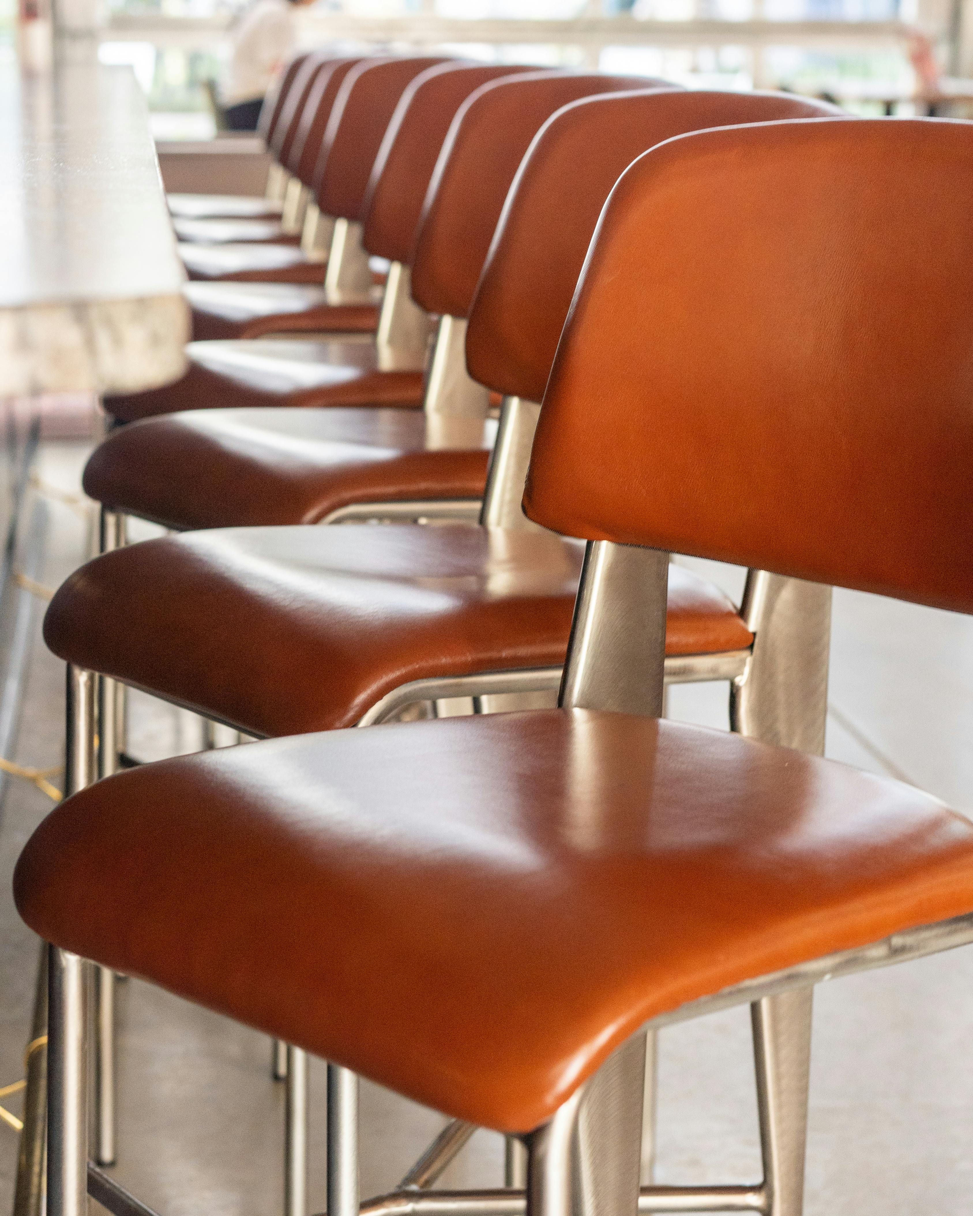 Lined Up Brown Chairs on the Counter · Free Stock Photo