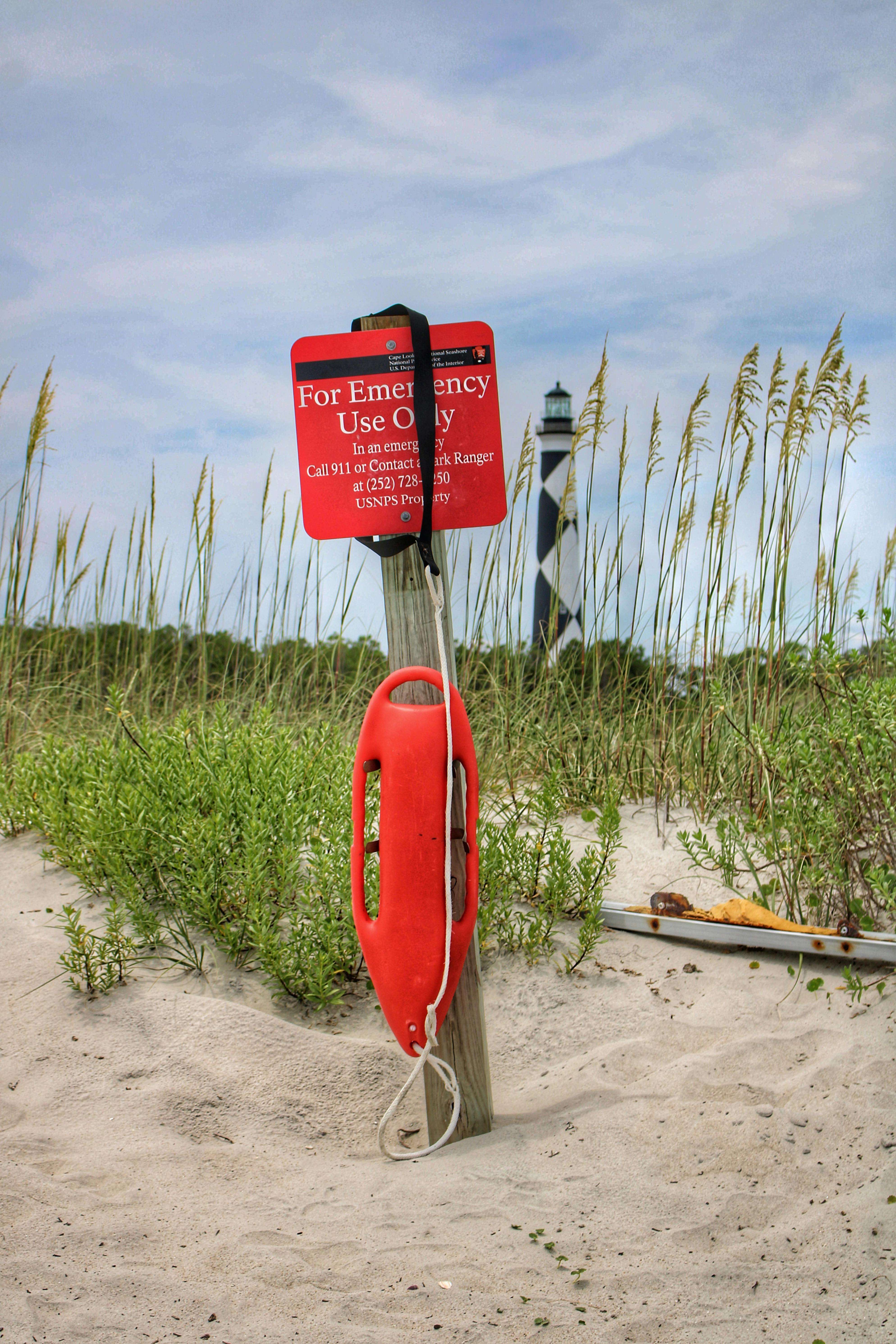 An Emergency Rescue Tube on a Wooden Post · Free Stock Photo