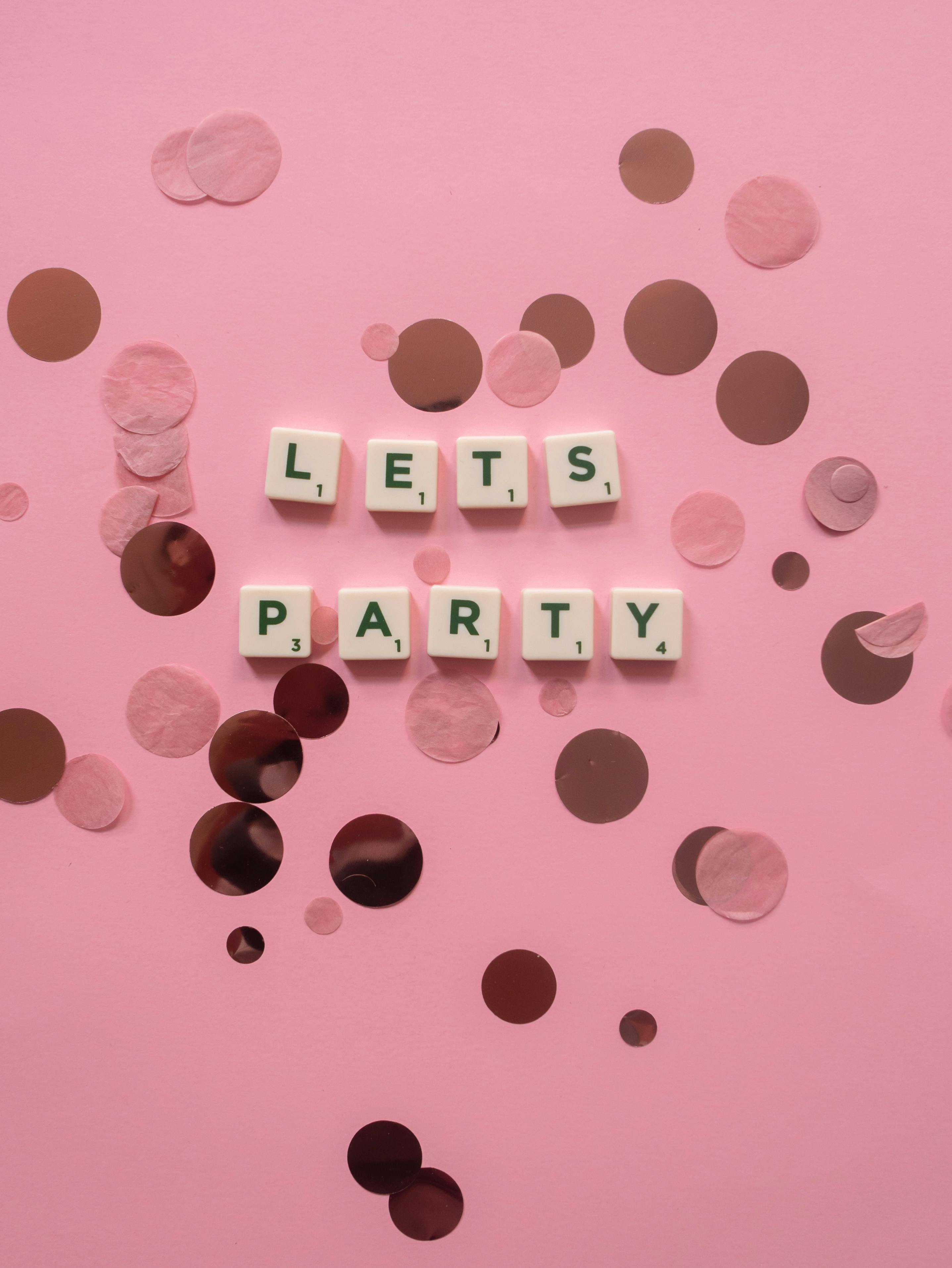Scrabble Tiles on a Pink Surface Surrounded by Circle Cut Out Papers ...