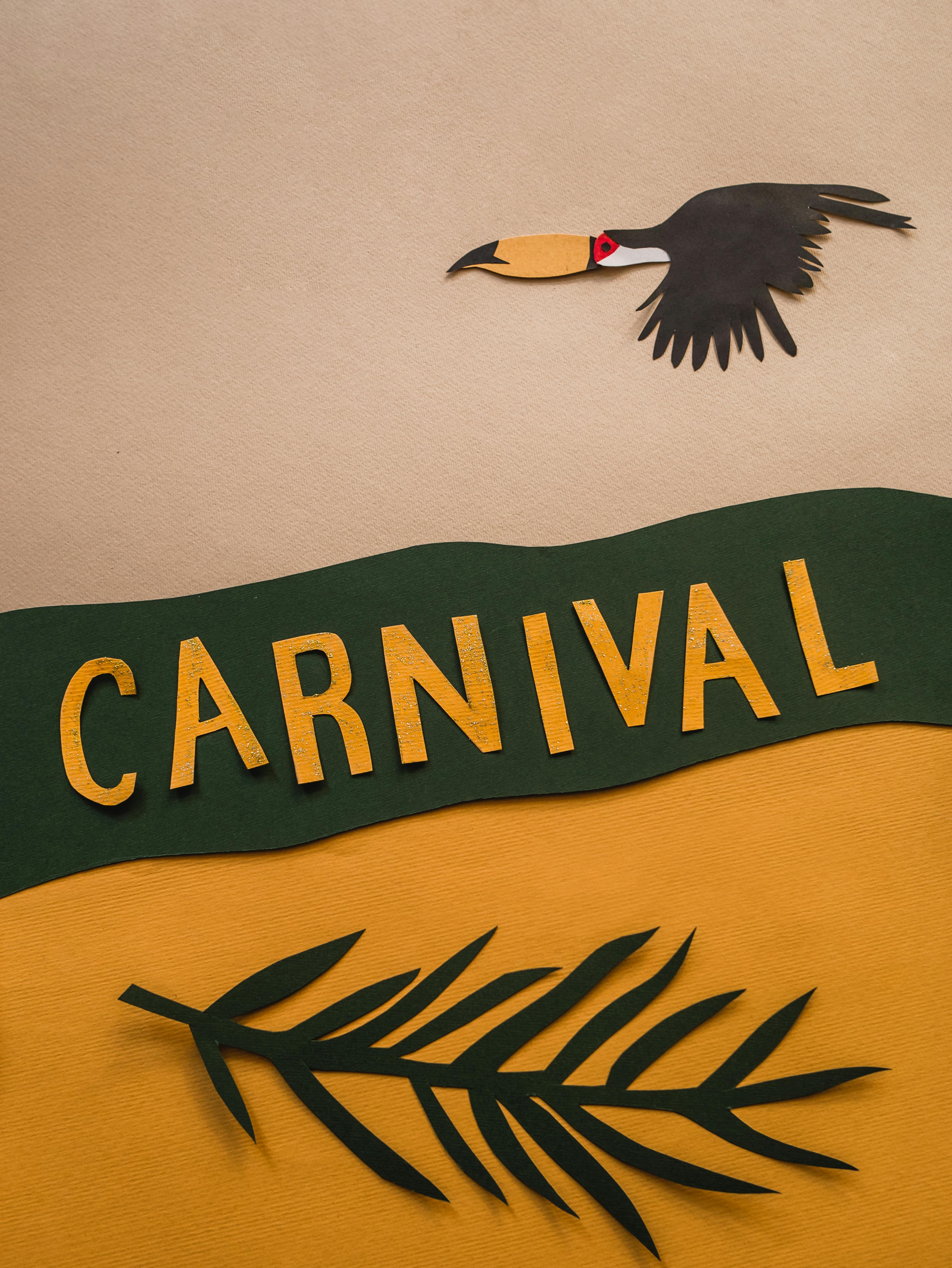 Photo of a Paper Bird Near the Word Carnival · Free Stock Photo