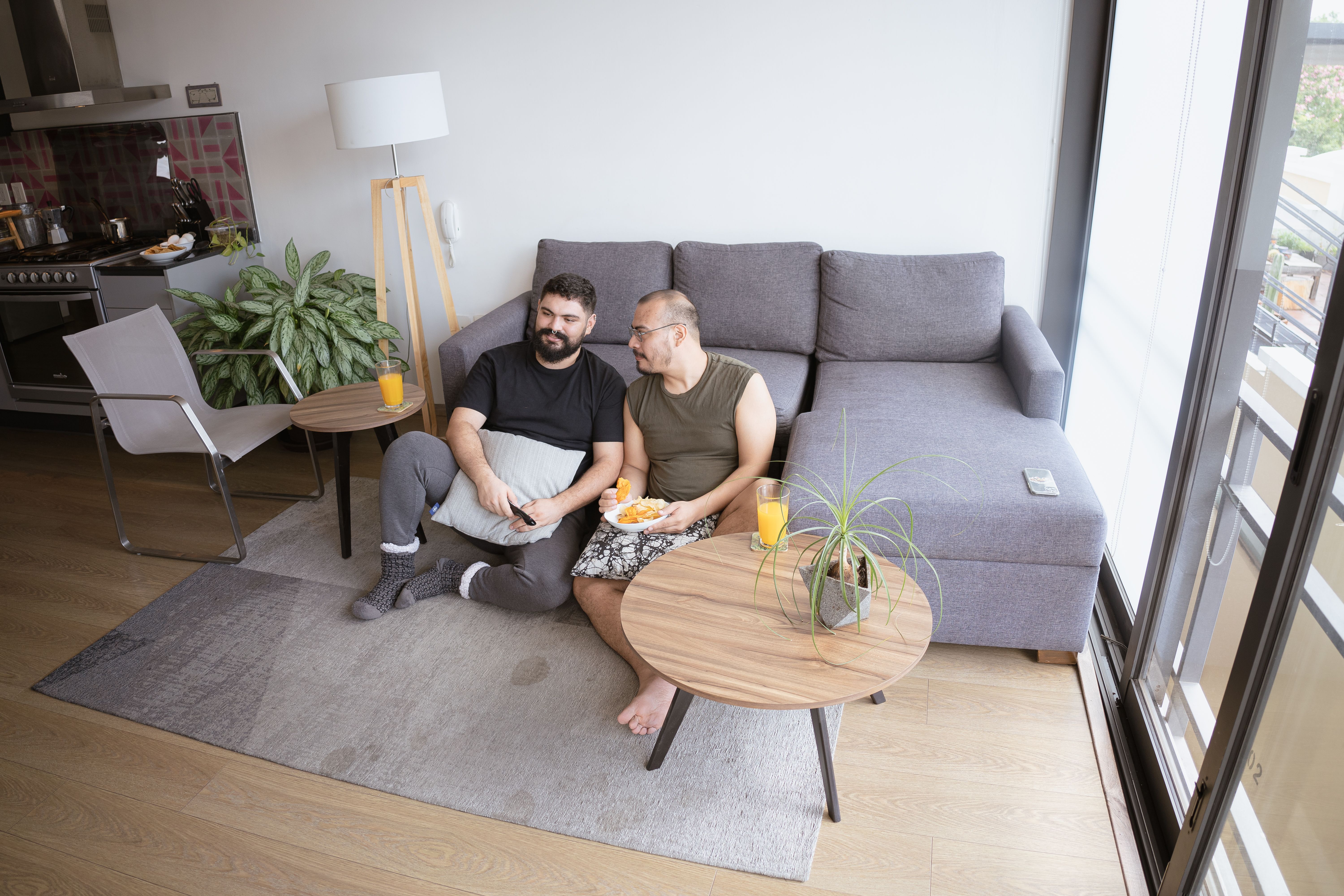 Photograph of Men Sitting on a Gray Rug · Free Stock Photo