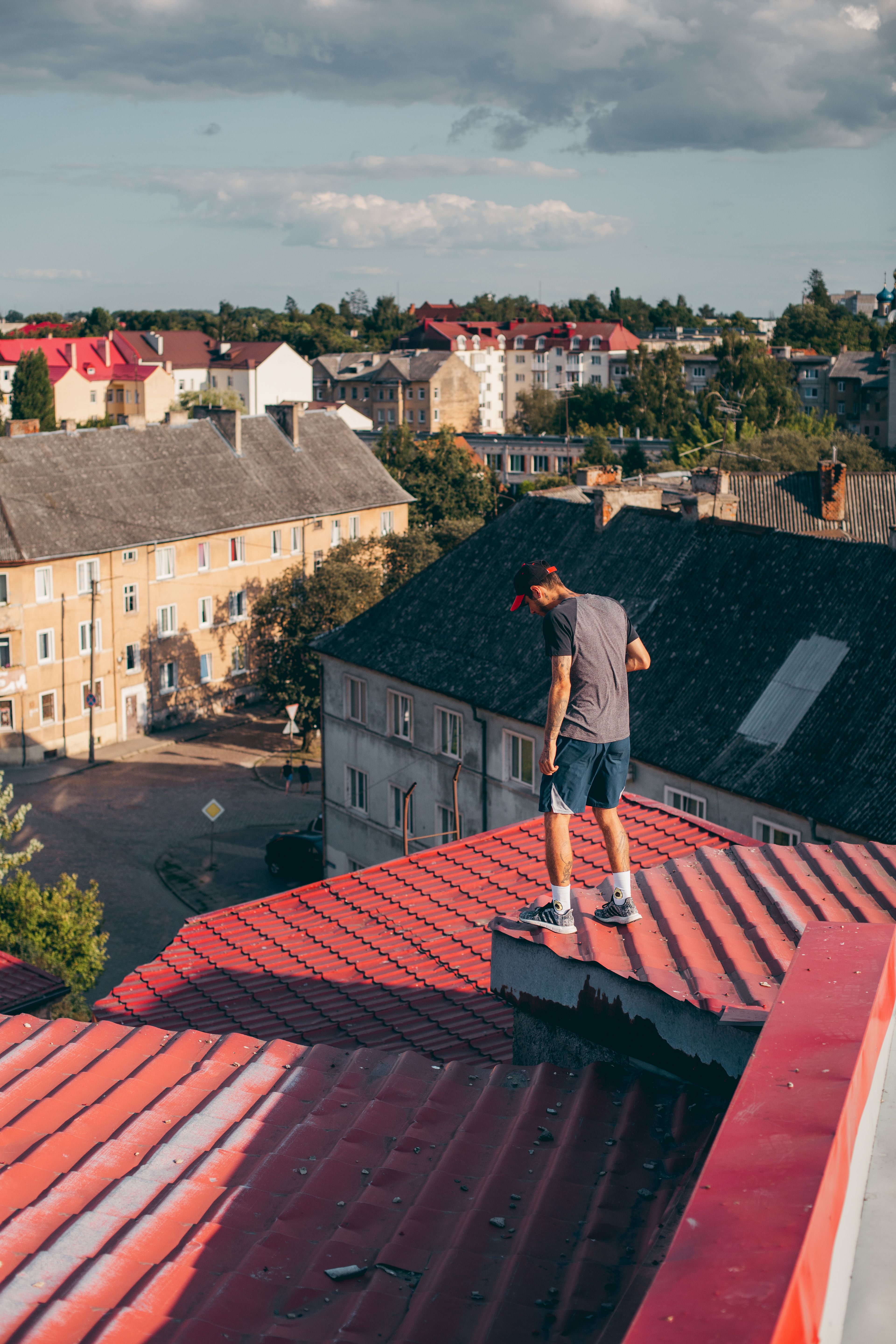 Person Standing on Roof under Moonlit Sky · Free Stock Photo