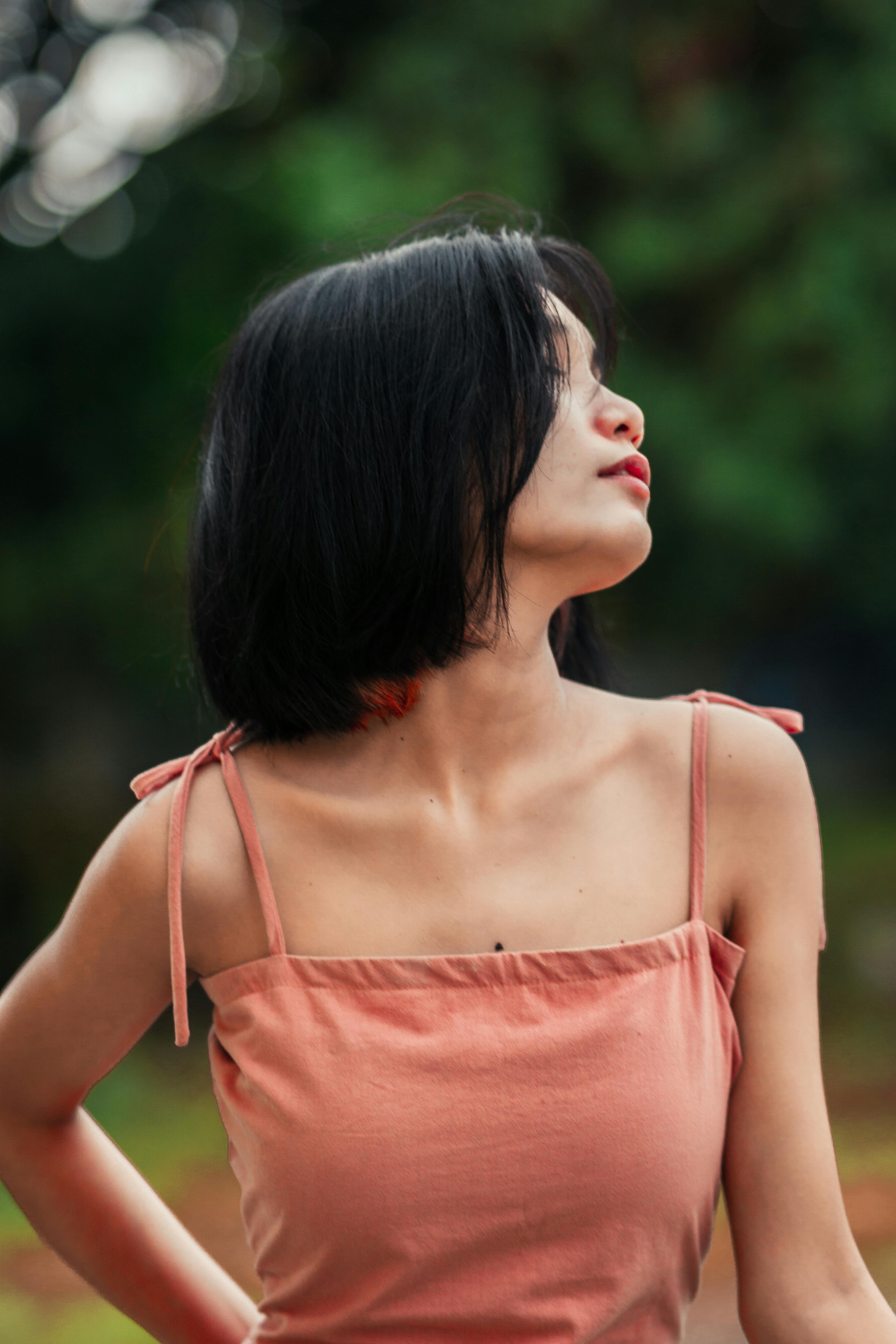 A Woman in Trendy Sunglasses and Black Spaghetti Strap Posing at the ...