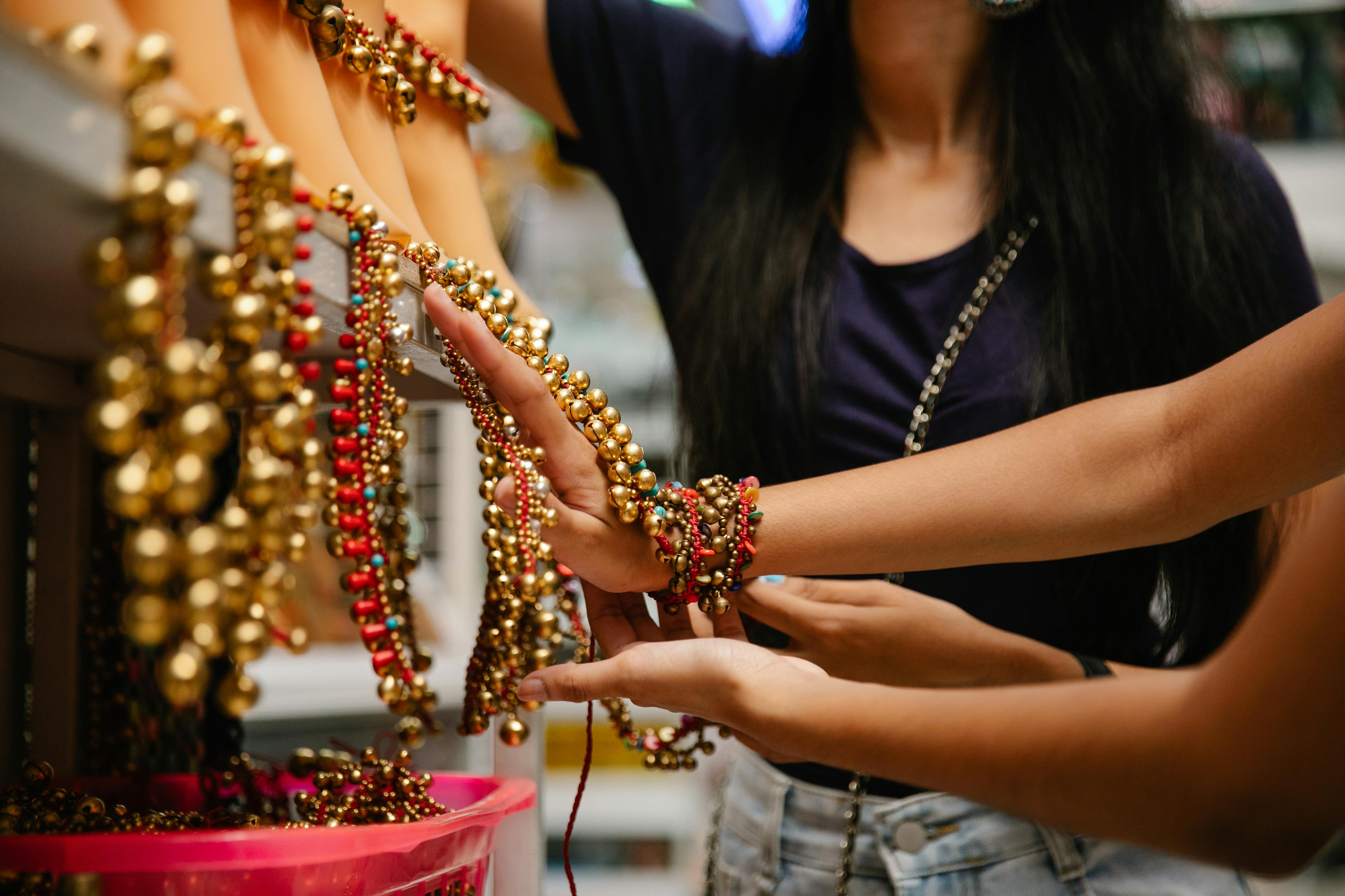 People Touching the Gold Beaded Accessories · Free Stock Photo