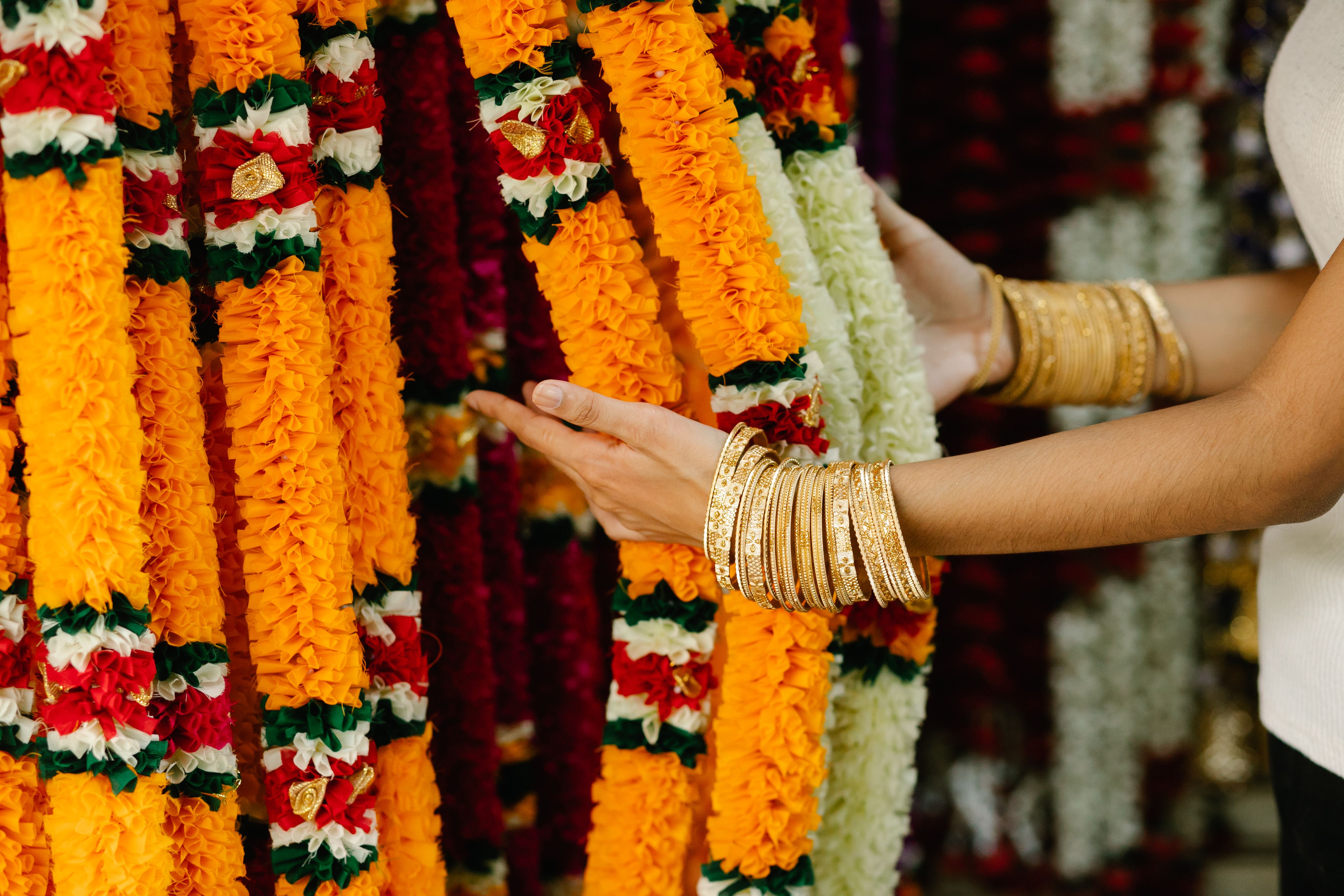 Woman Holding Traditional Artificial Flower Garlands · Free Stock Photo