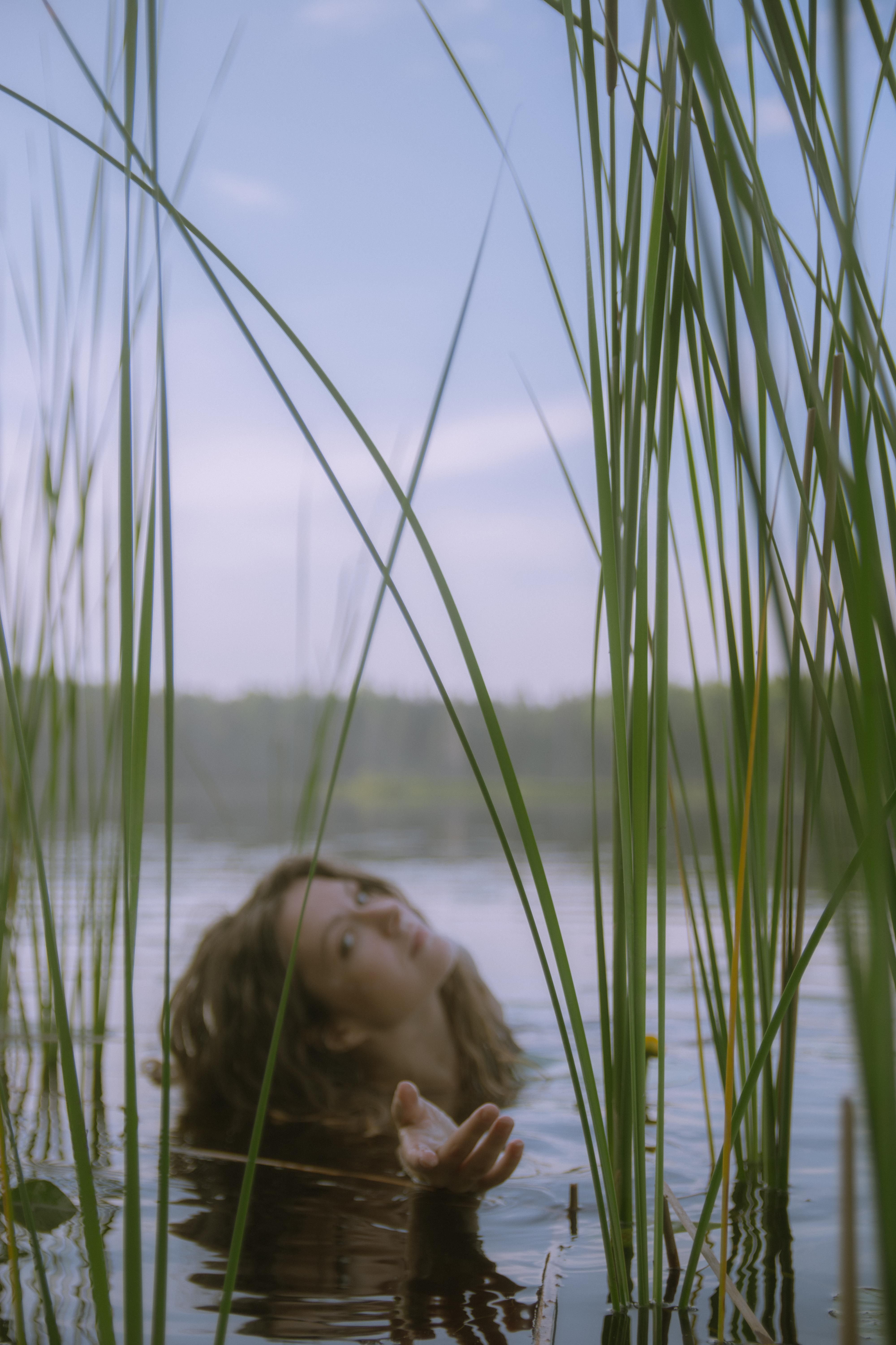Woman Reaching into Water · Free Stock Photo