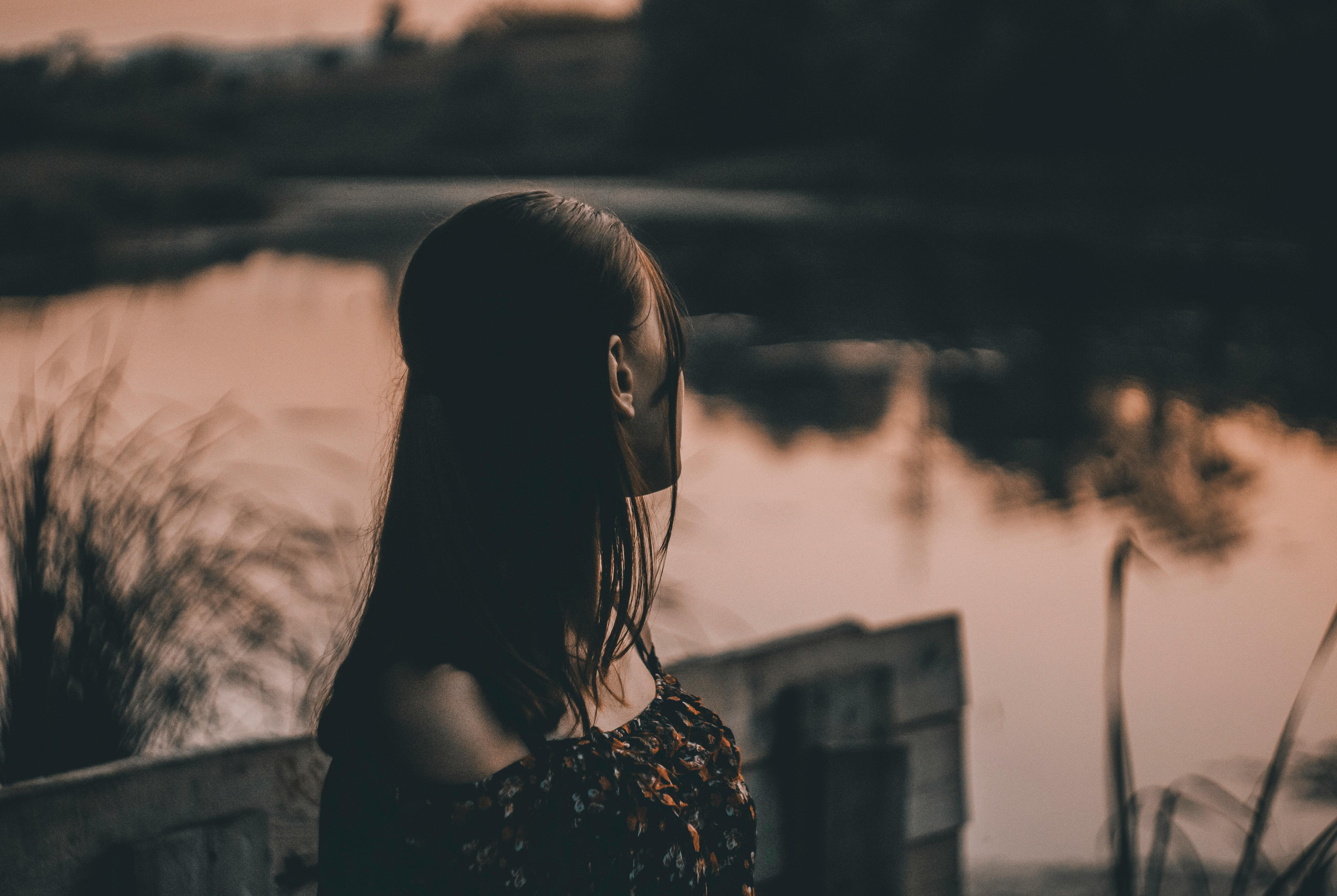 Side View of a Woman Looking the Water · Free Stock Photo