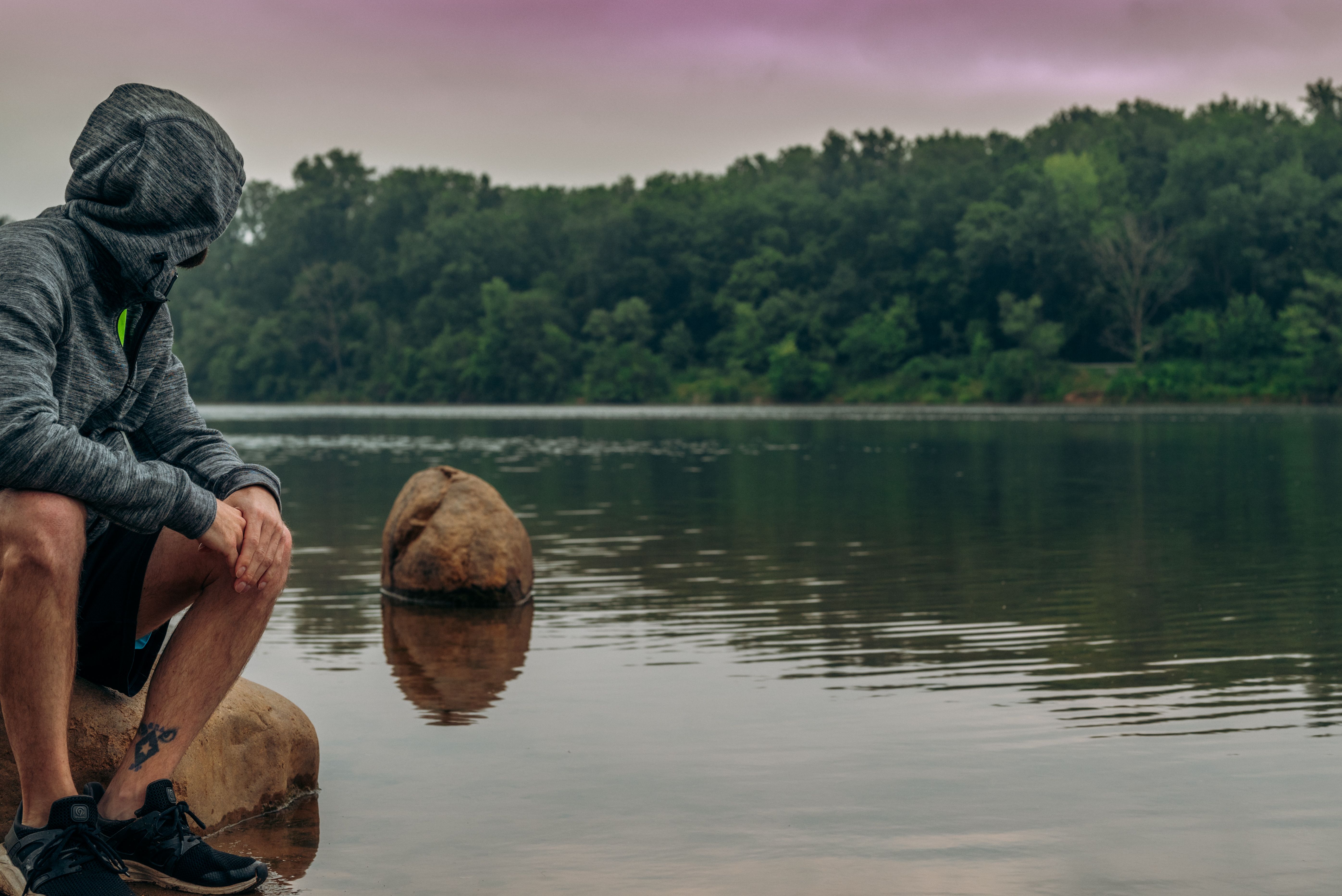 A Man Sitting Beside the River · Free Stock Photo