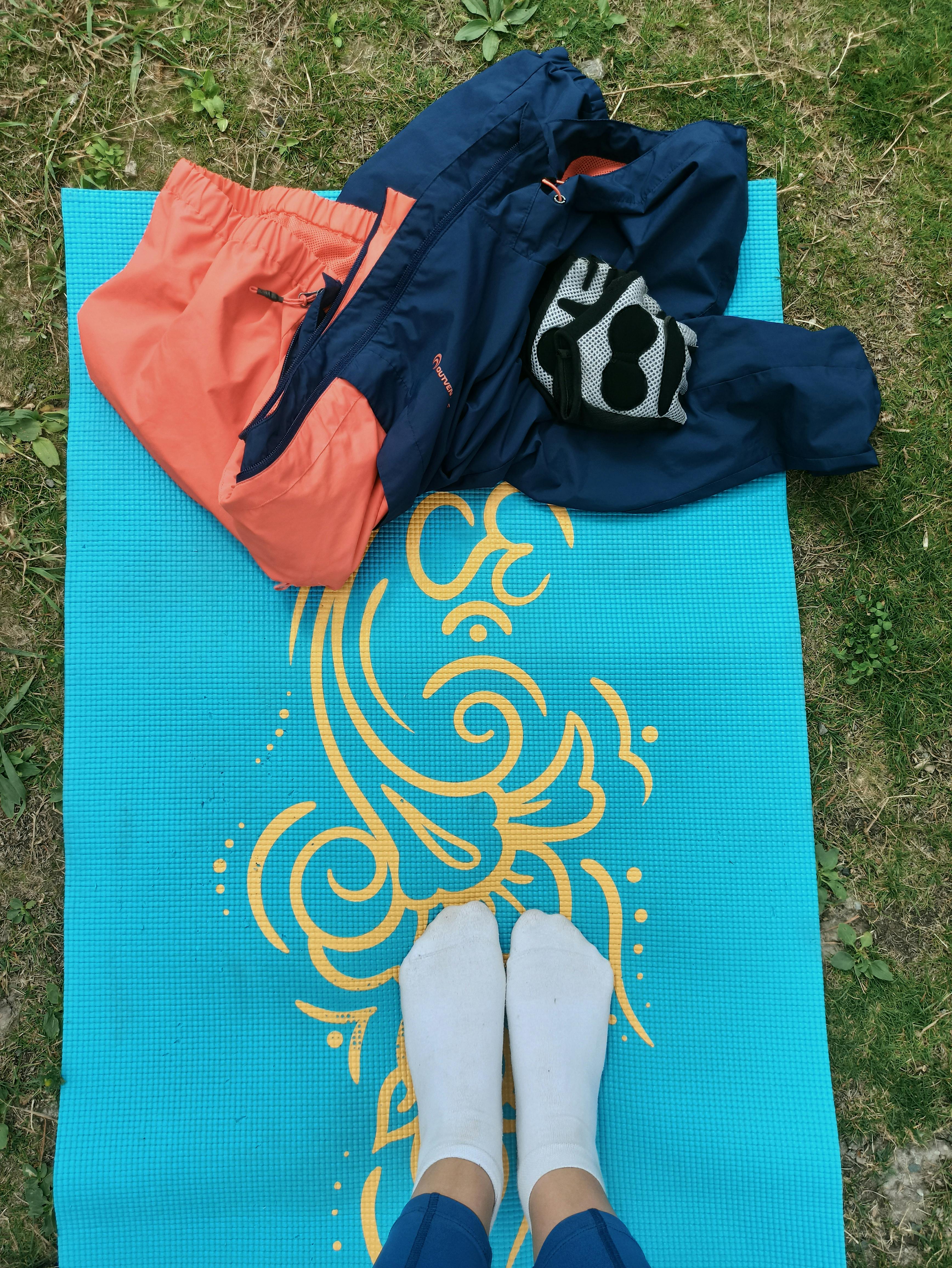 Standing on Blue Mat While Wearing Socks · Free Stock Photo