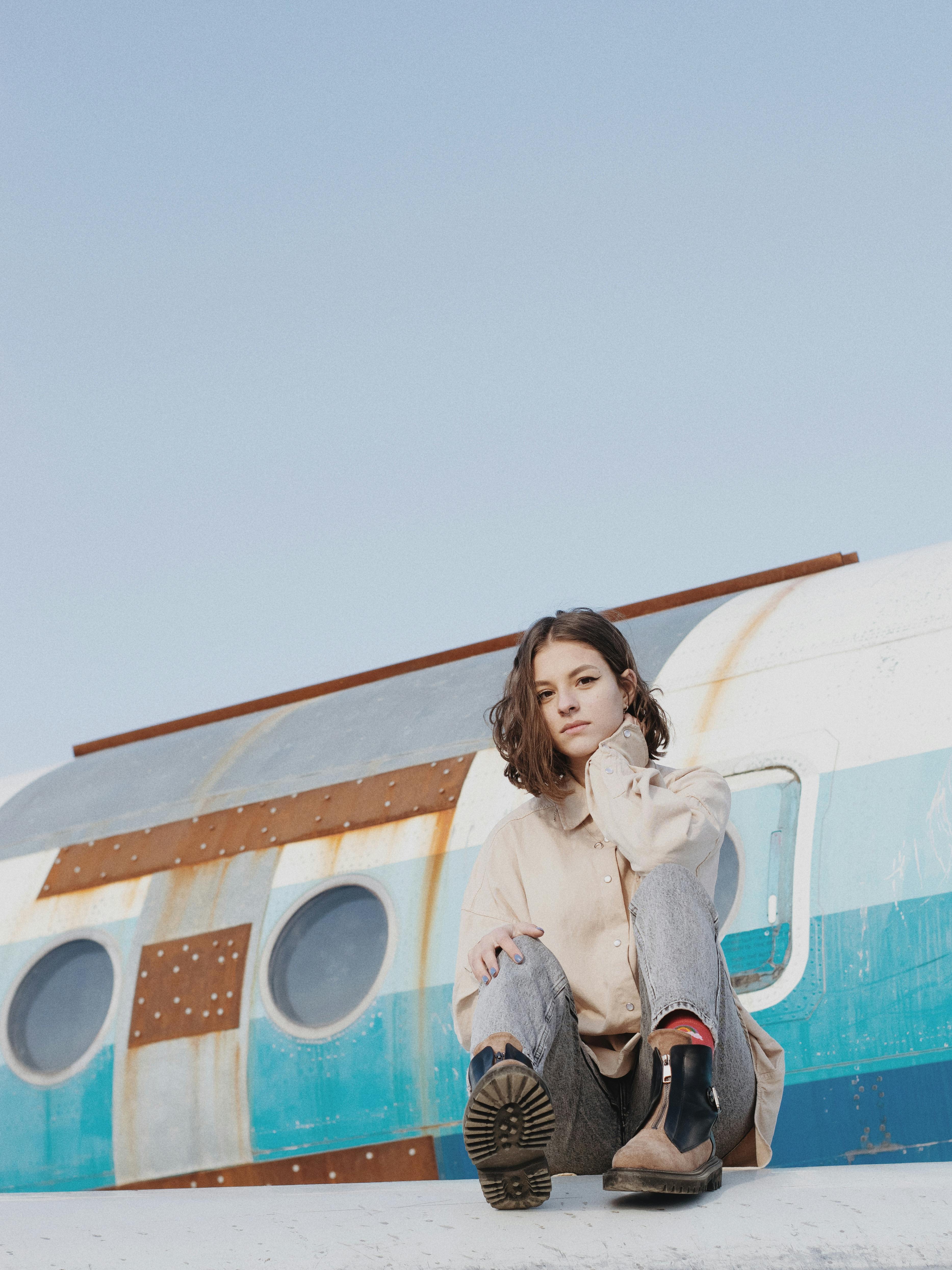 Female Model Wearing a Red Bikini Posing on a Wing of a Stationary ...