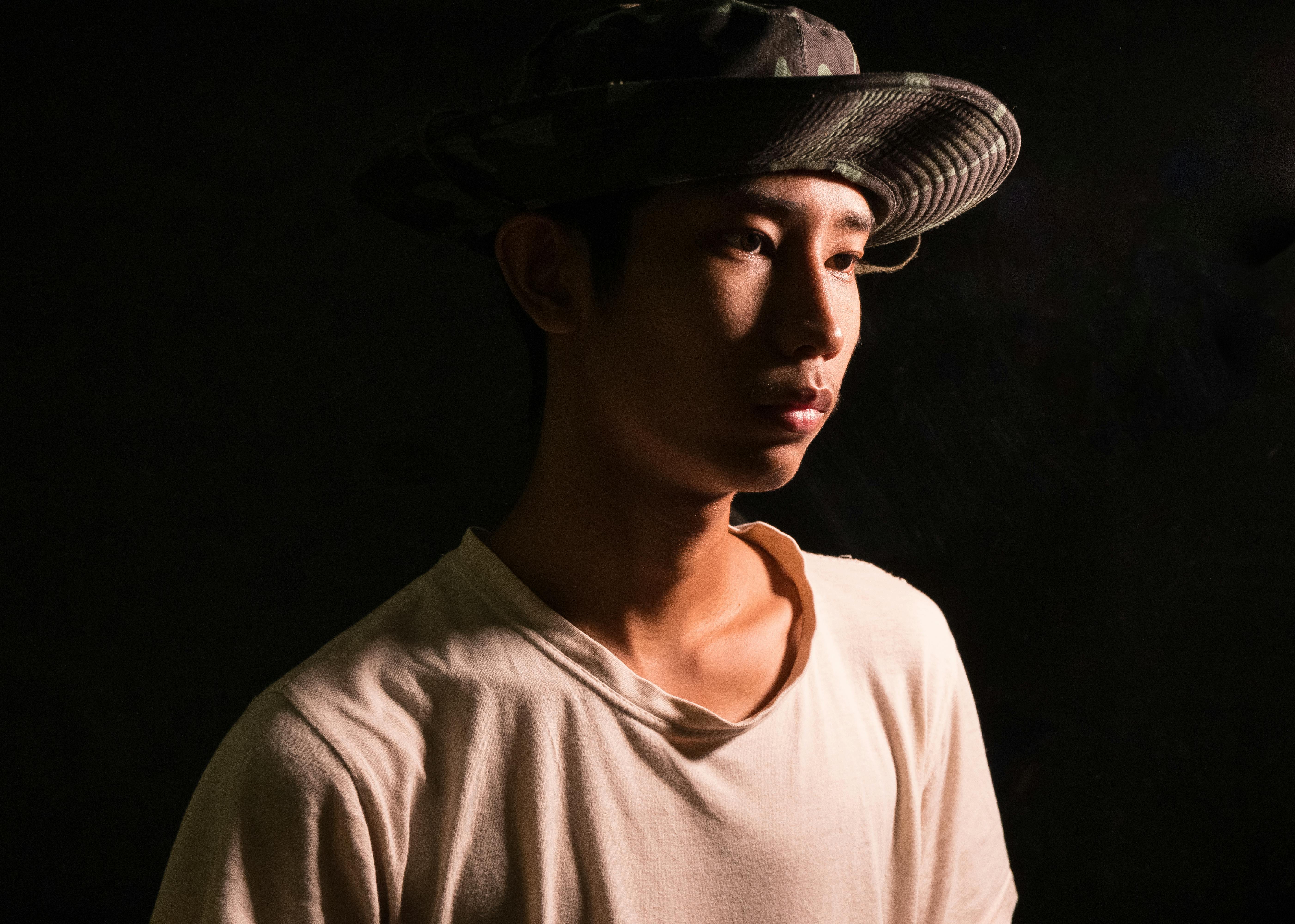 Woman in Shadow Posing on Studio Background · Free Stock Photo