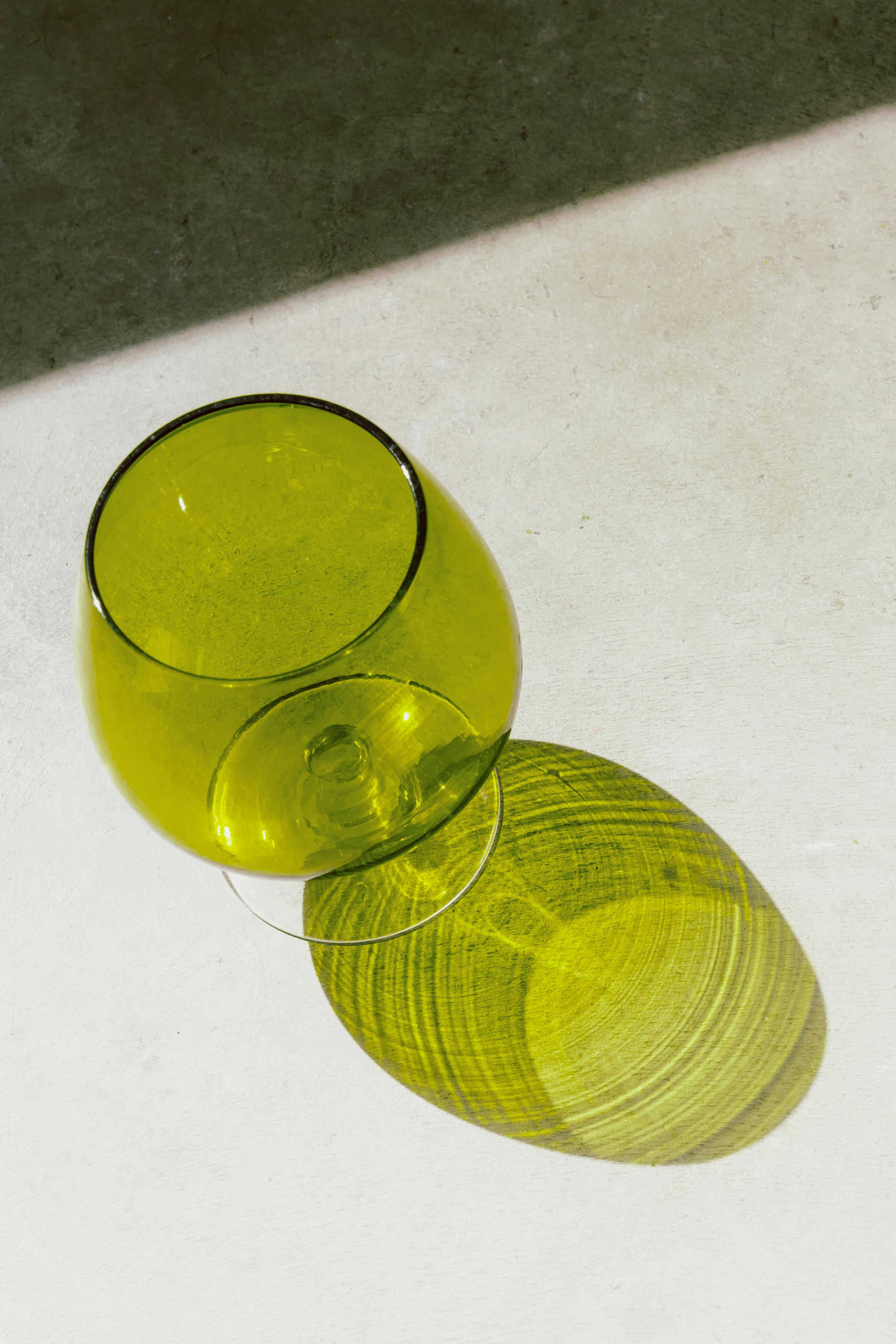 Clear and Colored Glasses on a Concrete Surface · Free Stock Photo
