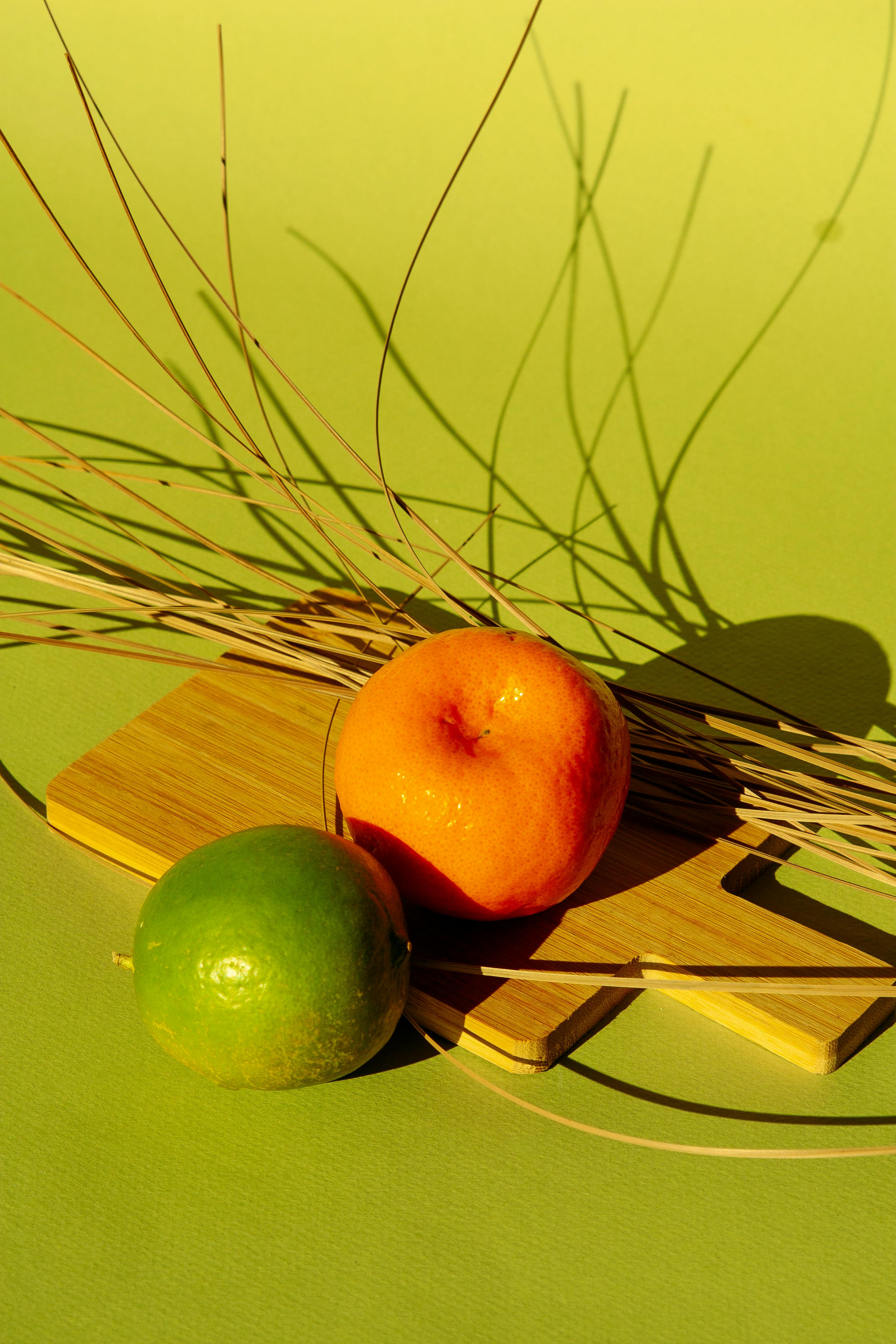 A Lighted Candle on a Wooden Chopping Board Beside a Mug with Cream ...