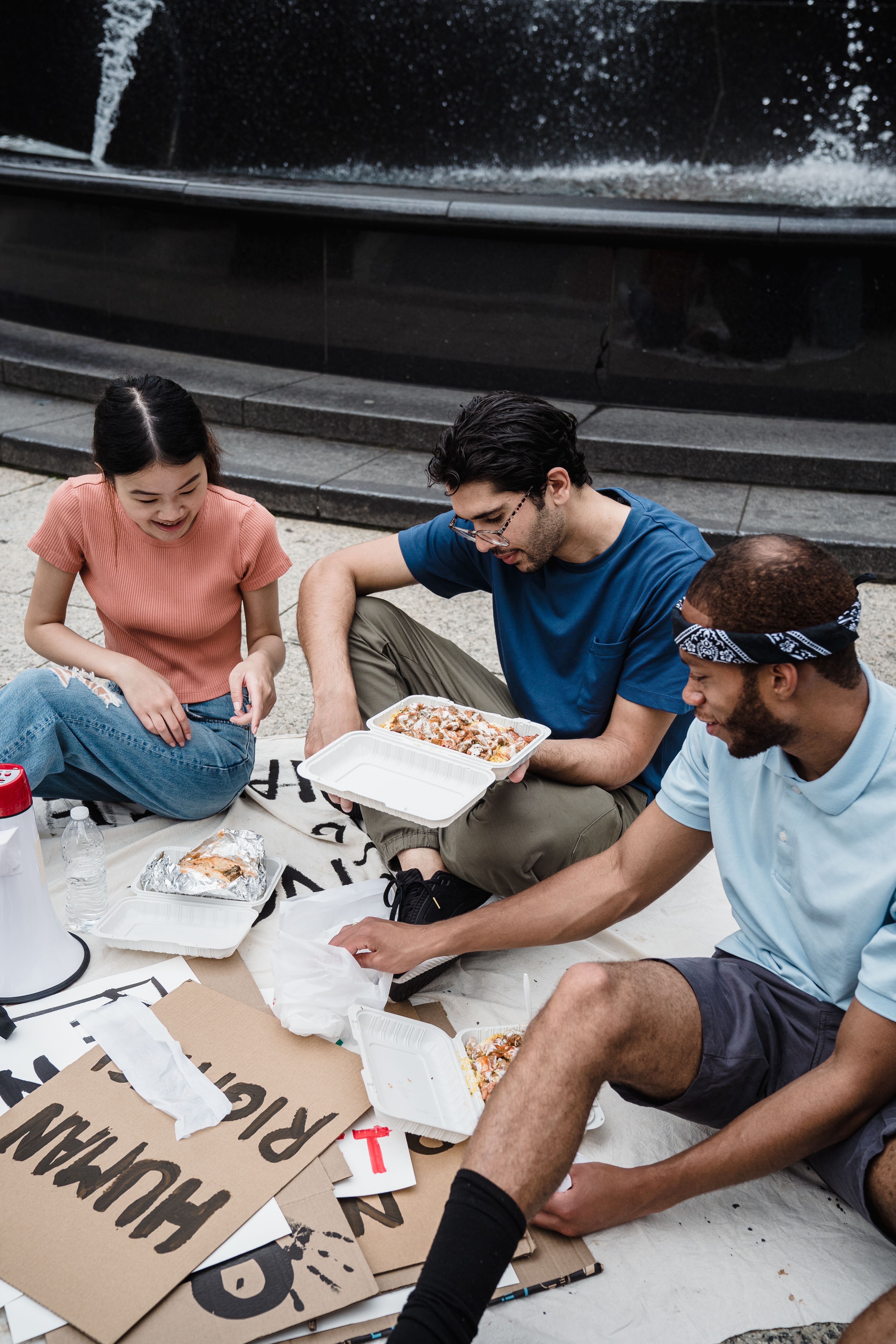 People Eating on Concrete Pavement · Free Stock Photo