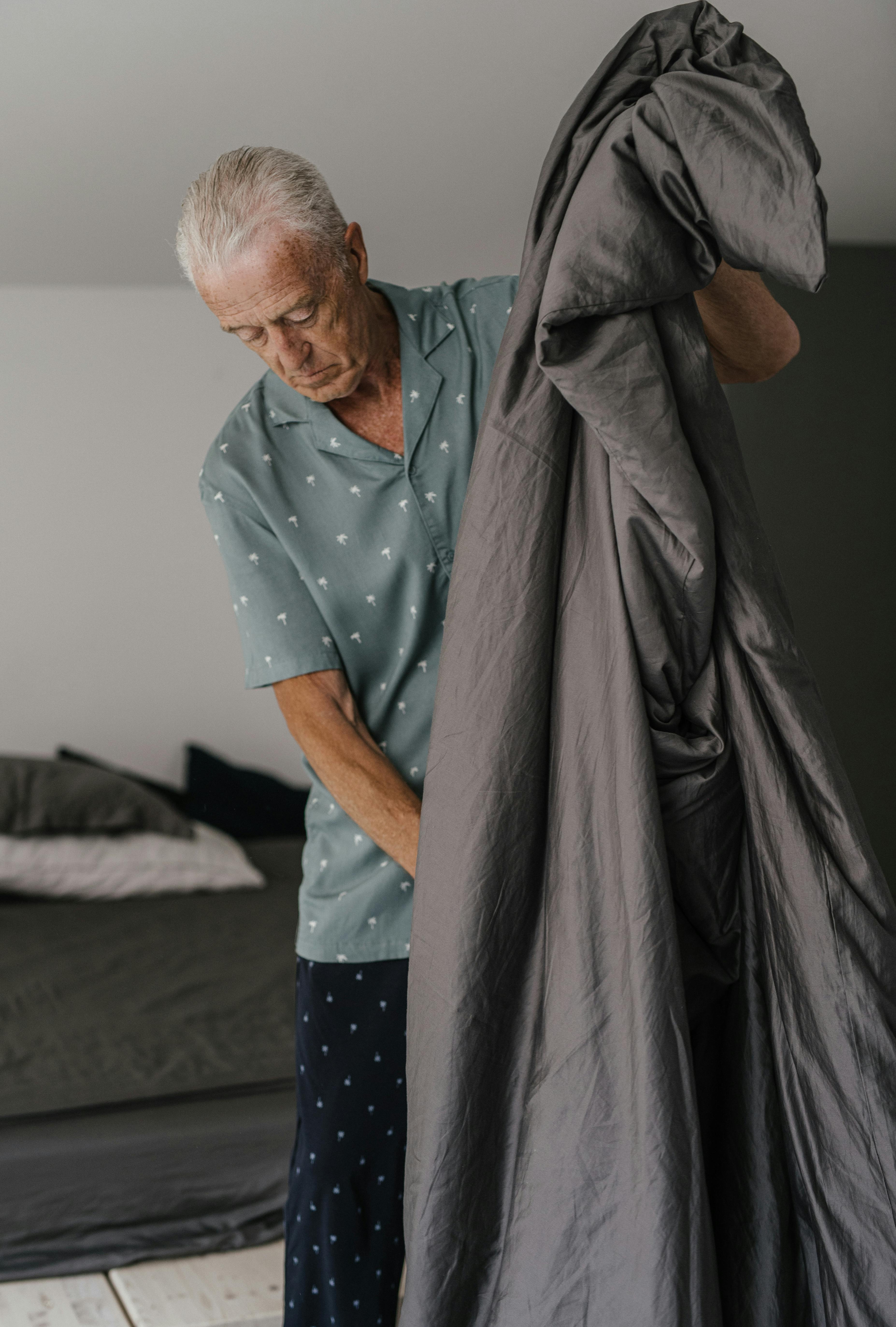 Man Sitting Holding Blanket over Head · Free Stock Photo