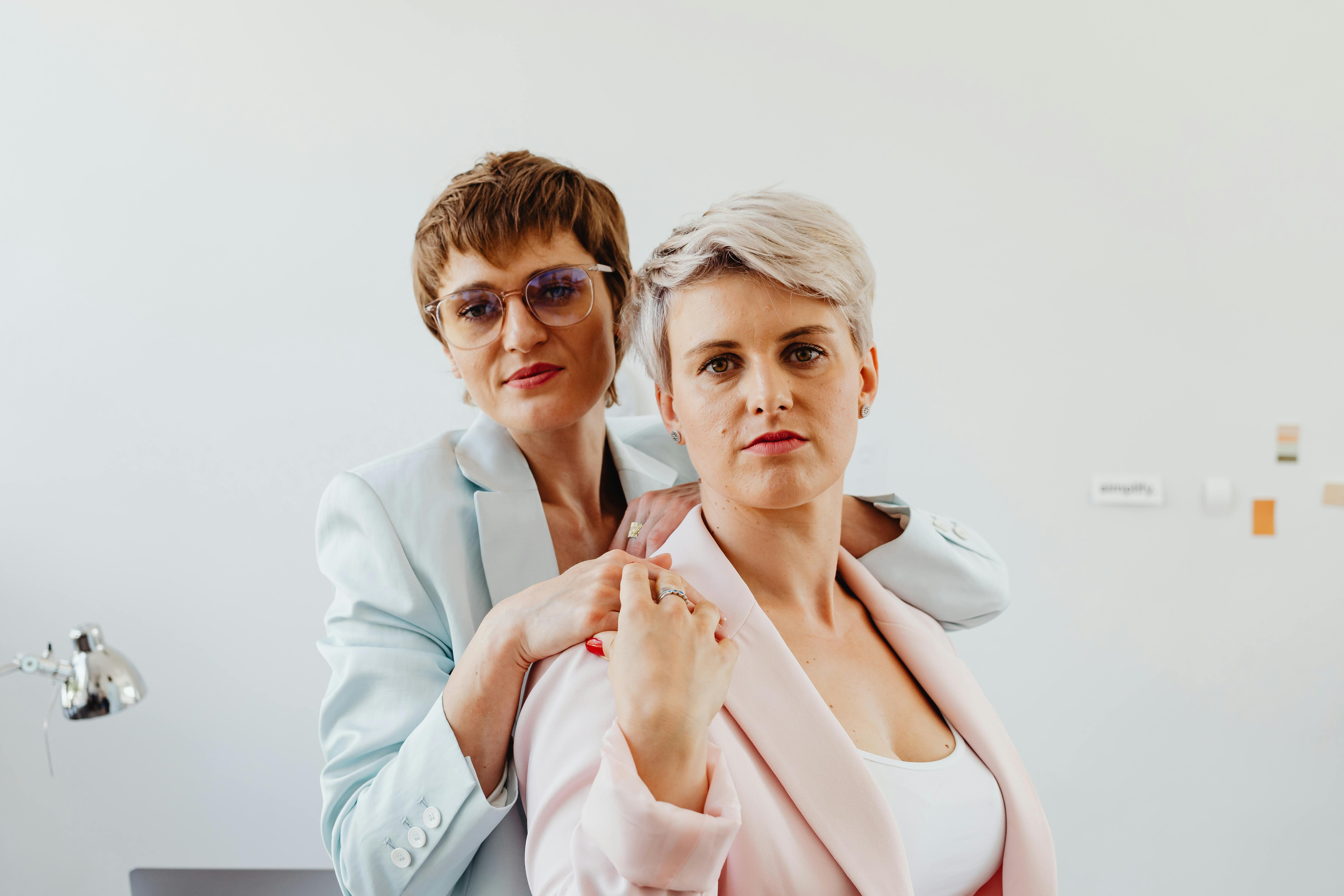 Woman in White Blazer Standing Behind a Woman in Pink Blazer · Free ...