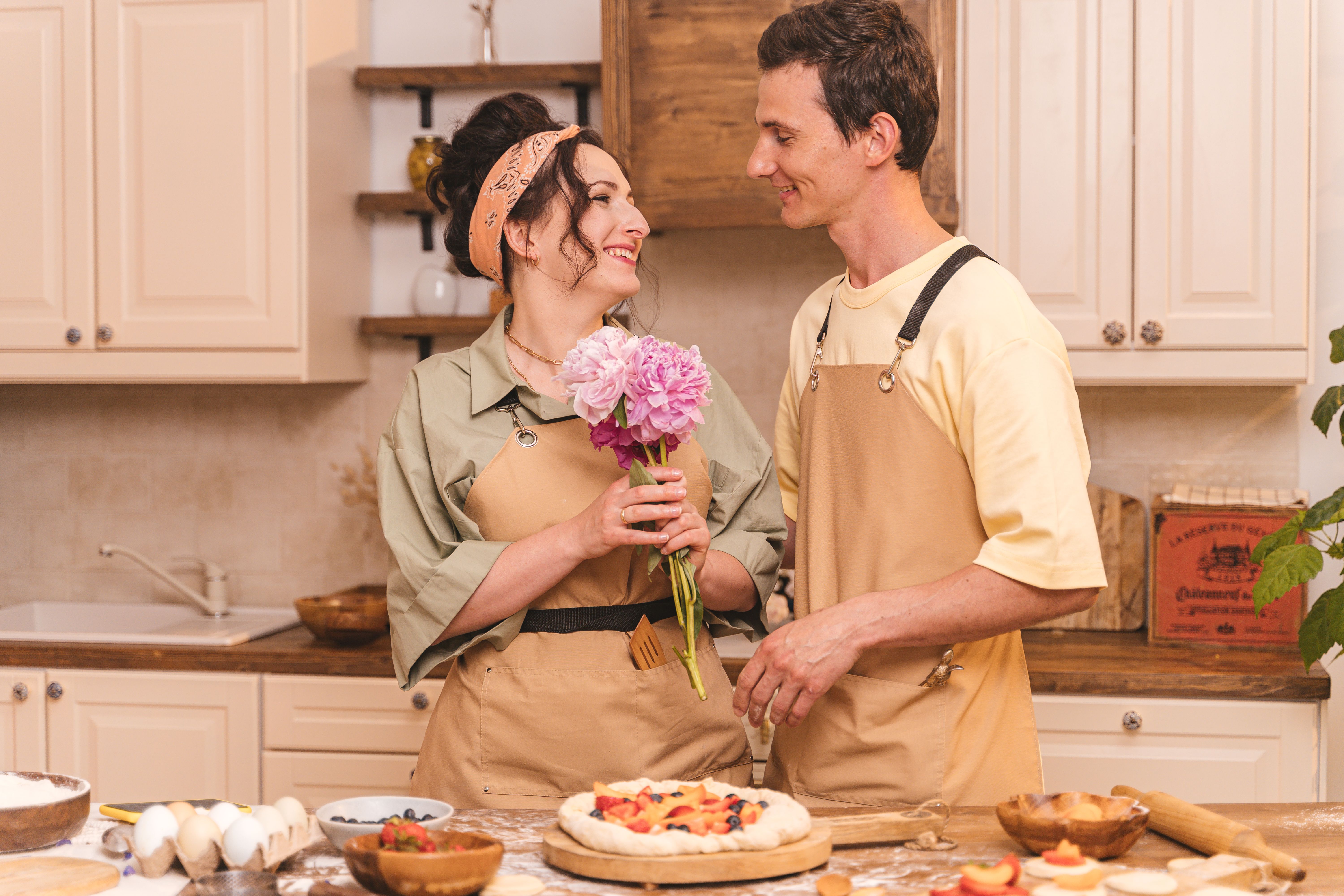 Couple with Bouquet in Kitchen · Free Stock Photo