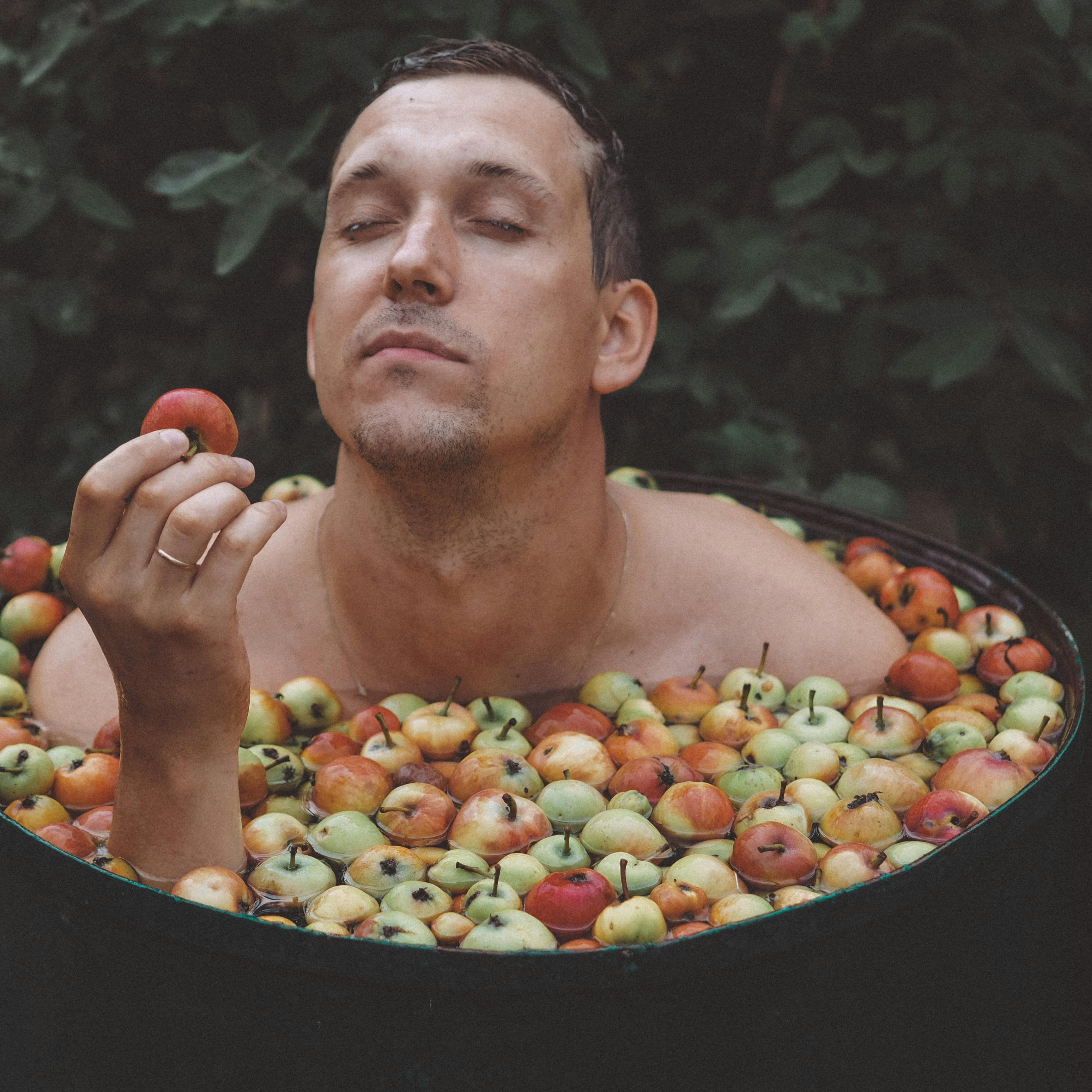 A Man Holding an Apple · Free Stock Photo