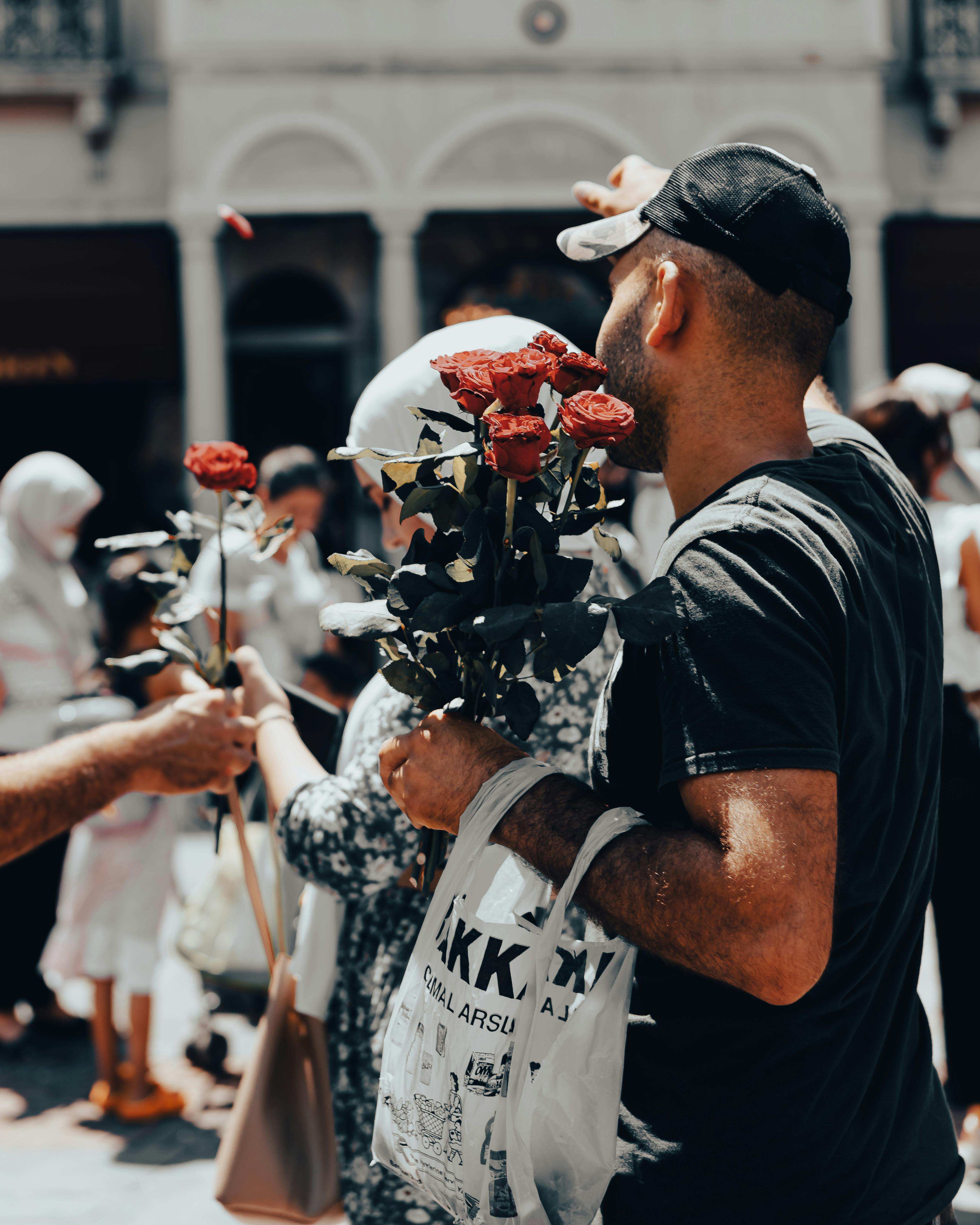 A Man Holding Red Roses · Free Stock Photo