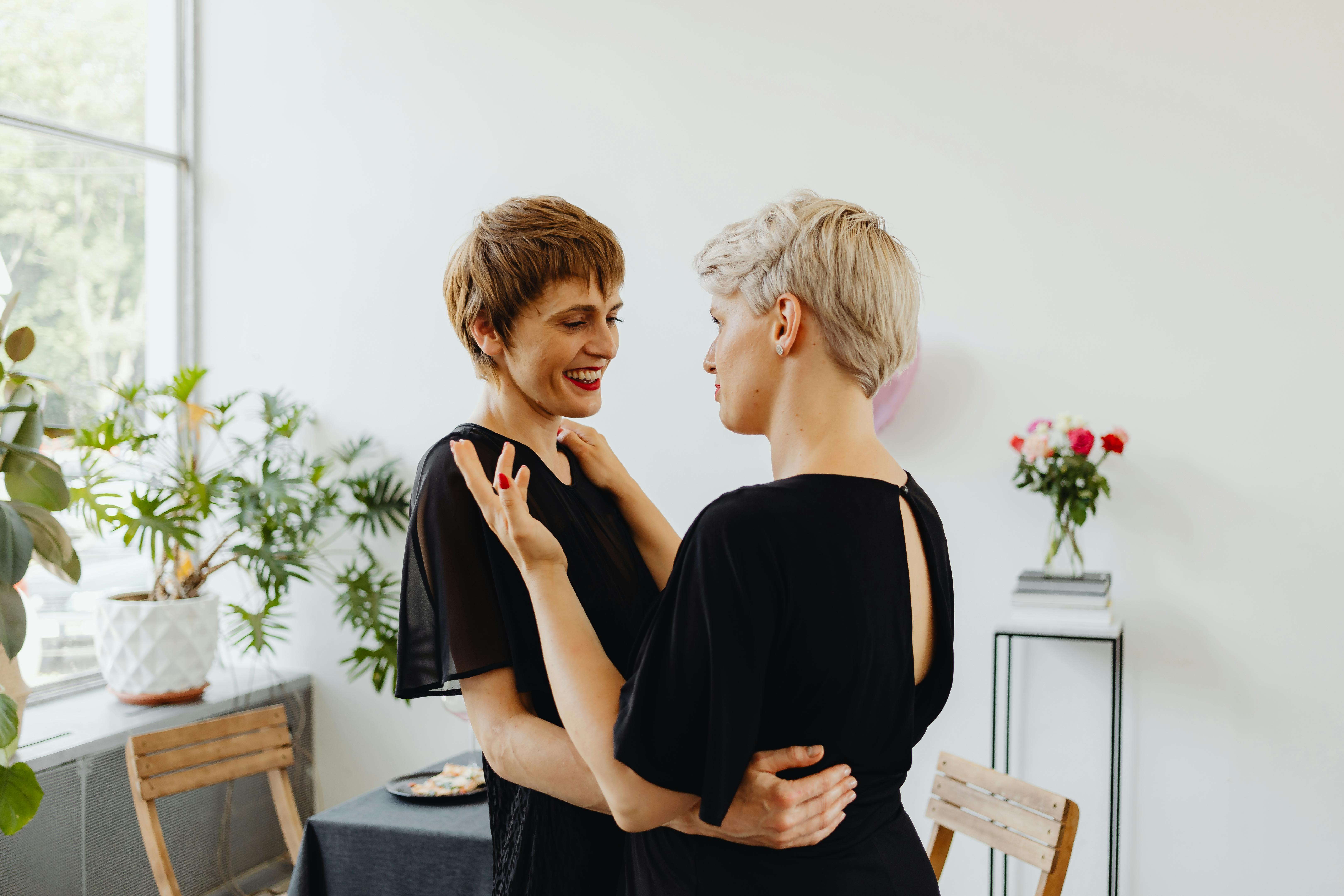 Women Standing Close Together Smiling at Each Other · Free Stock Photo