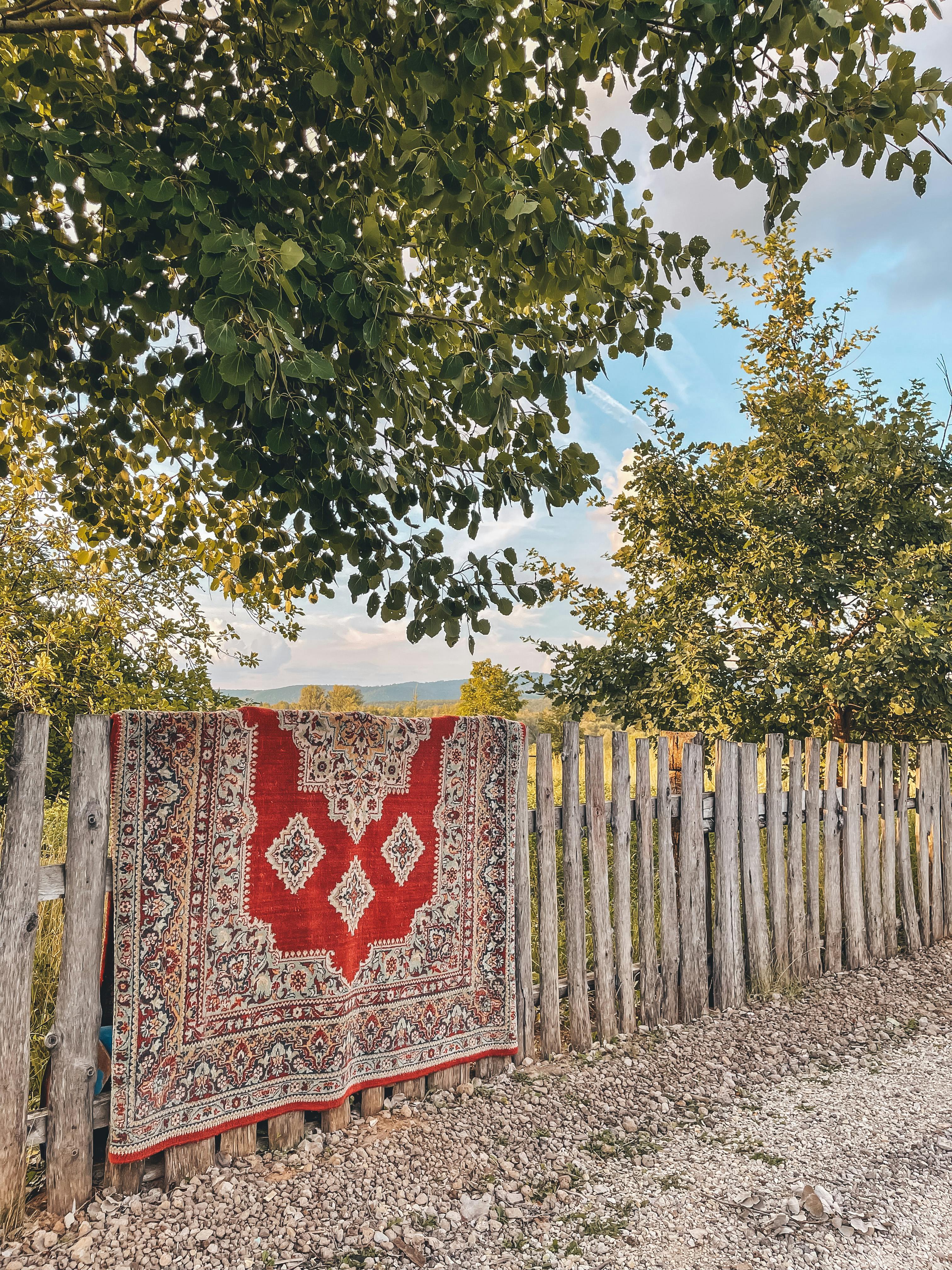 Decorated, Handmade Carpet on Wooden Fence · Free Stock Photo