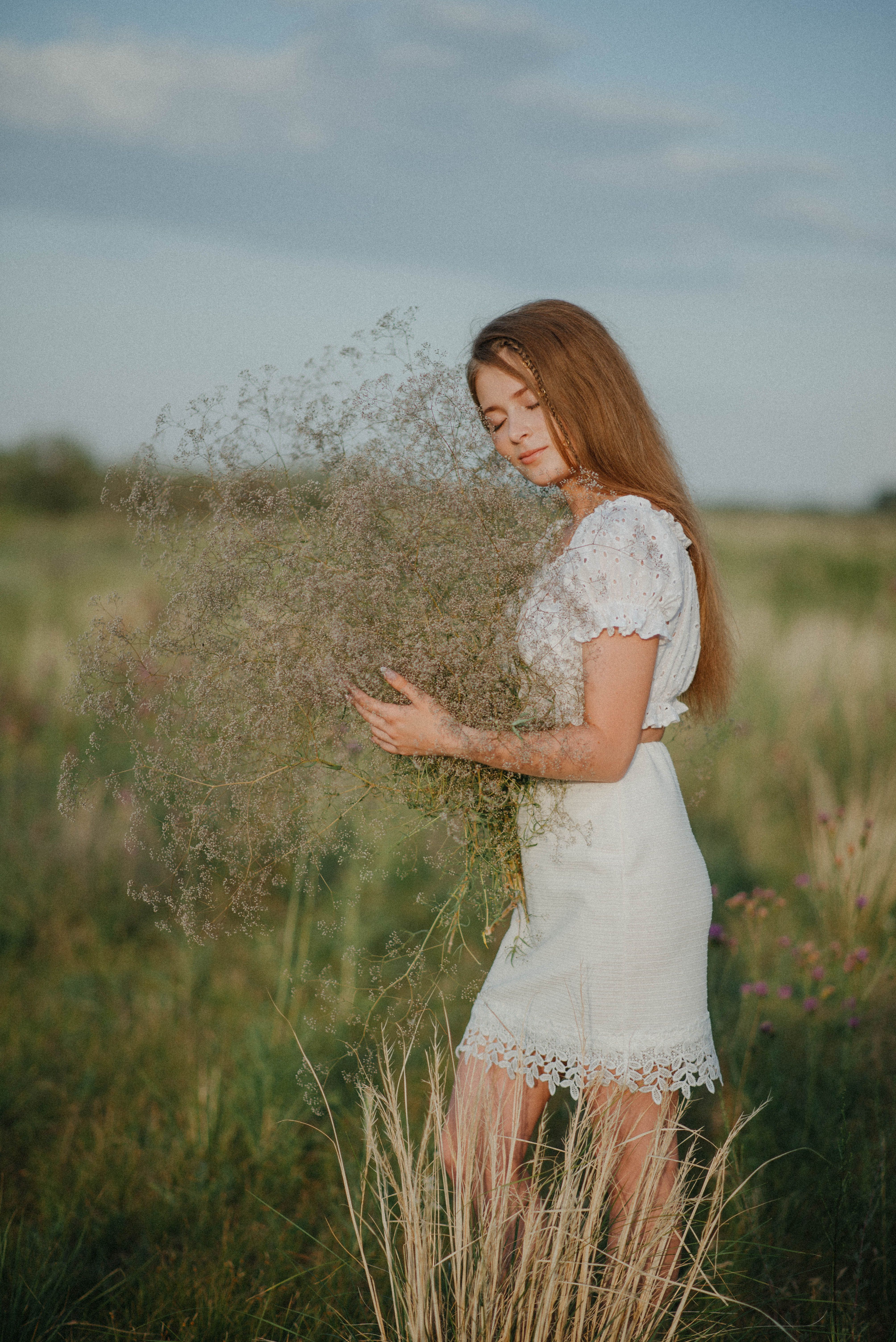 Woman Holding Grass · Free Stock Photo