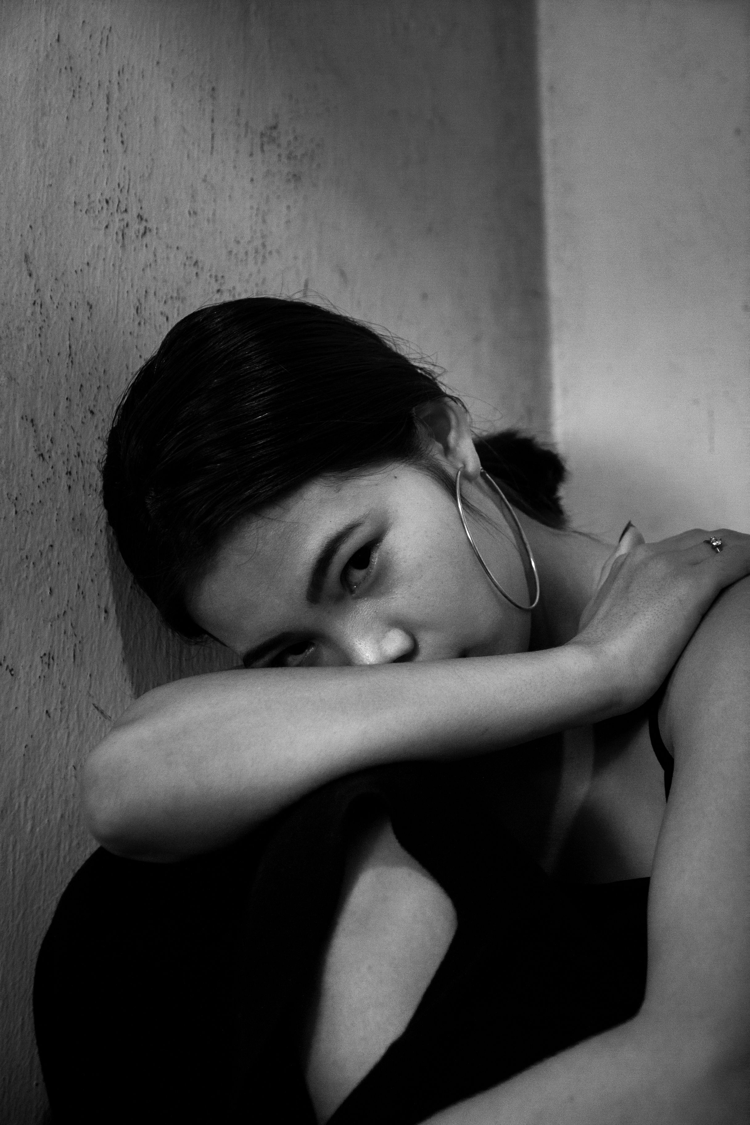 Grayscale Photography of Woman Resting Face on Knee · Free Stock Photo