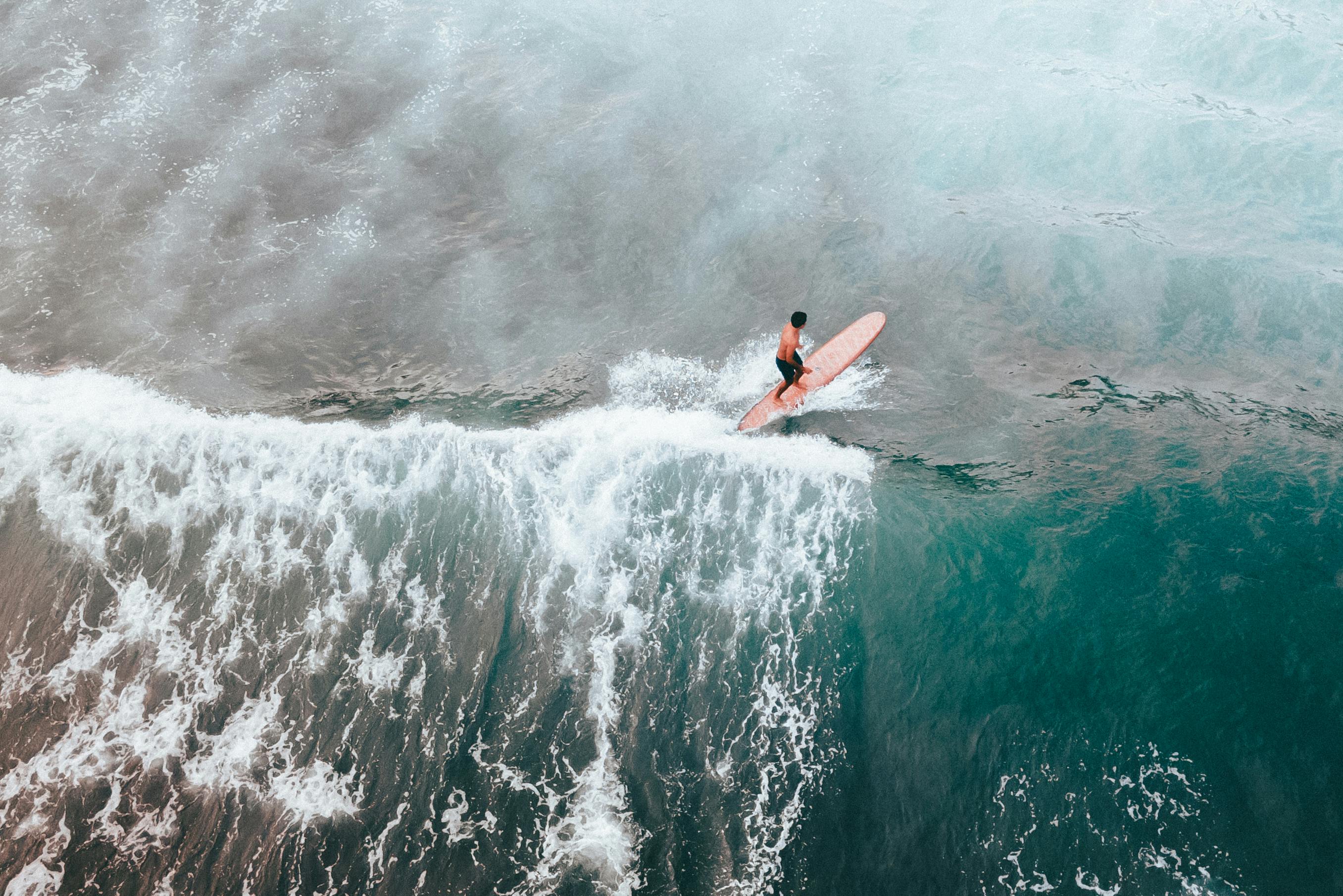 Top View of a Man Surfing on the Sea · Free Stock Photo