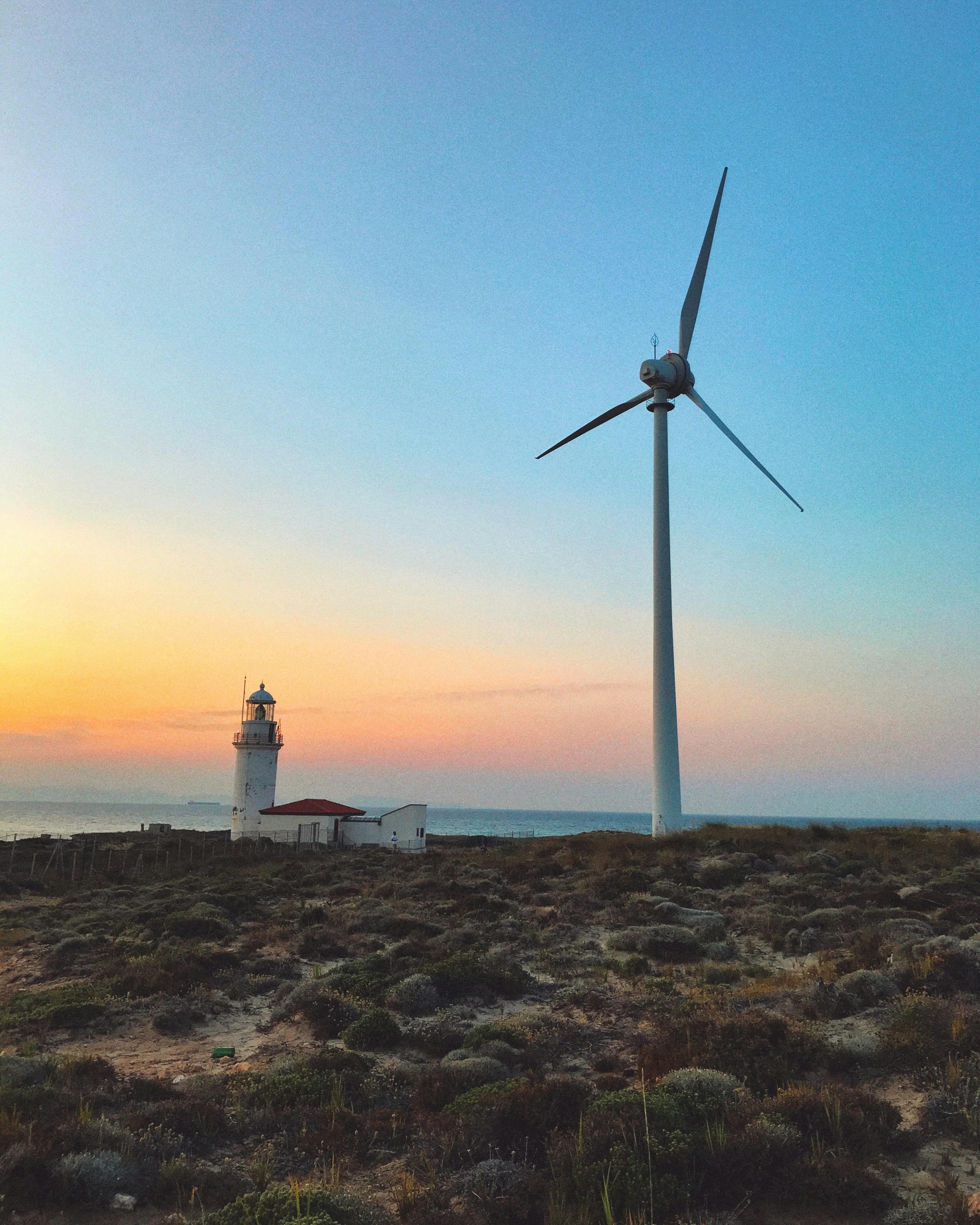 Wind Turbine Beside a Lighthouse · Free Stock Photo