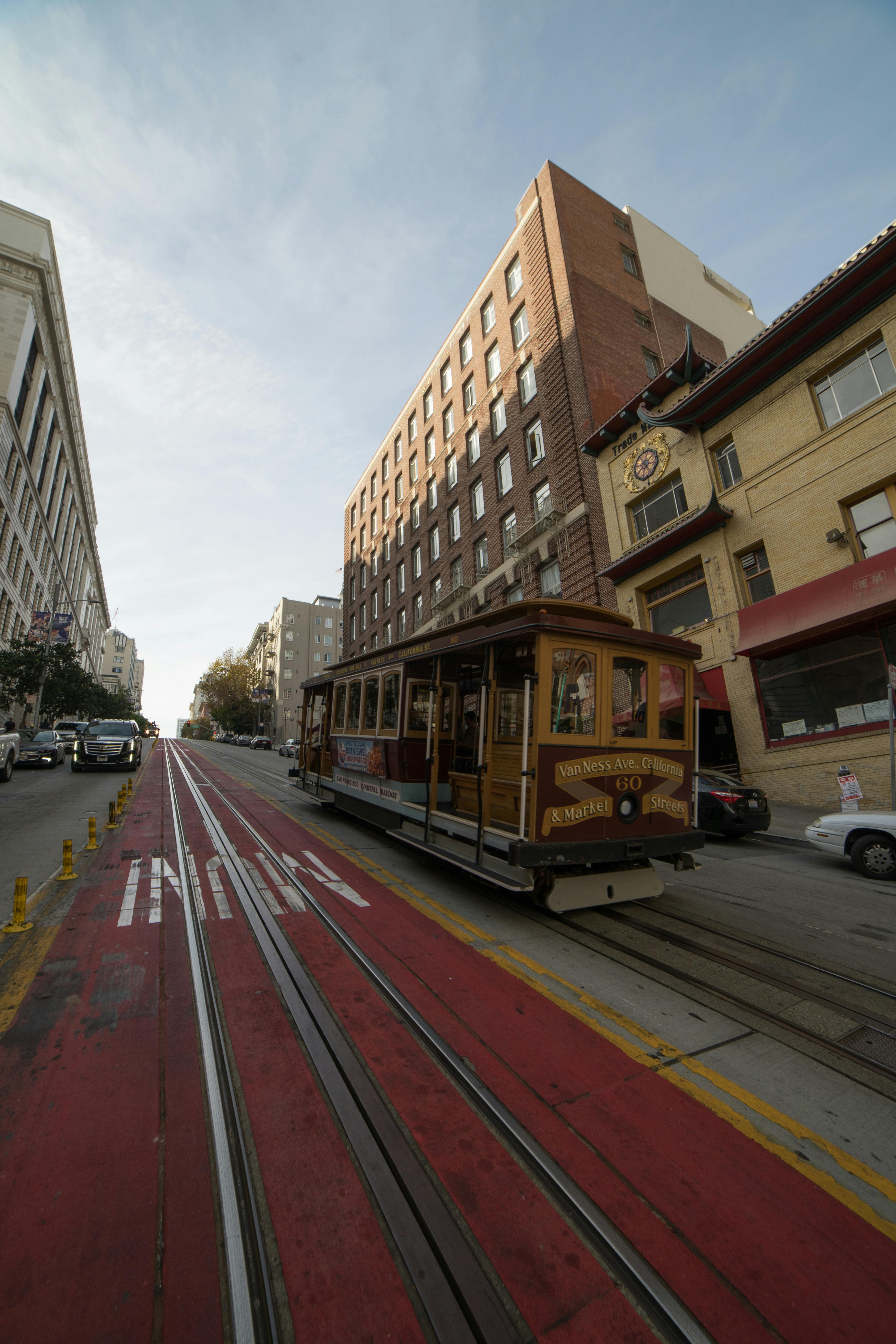 City Tram on the Road Beside the Buildings · Free Stock Photo
