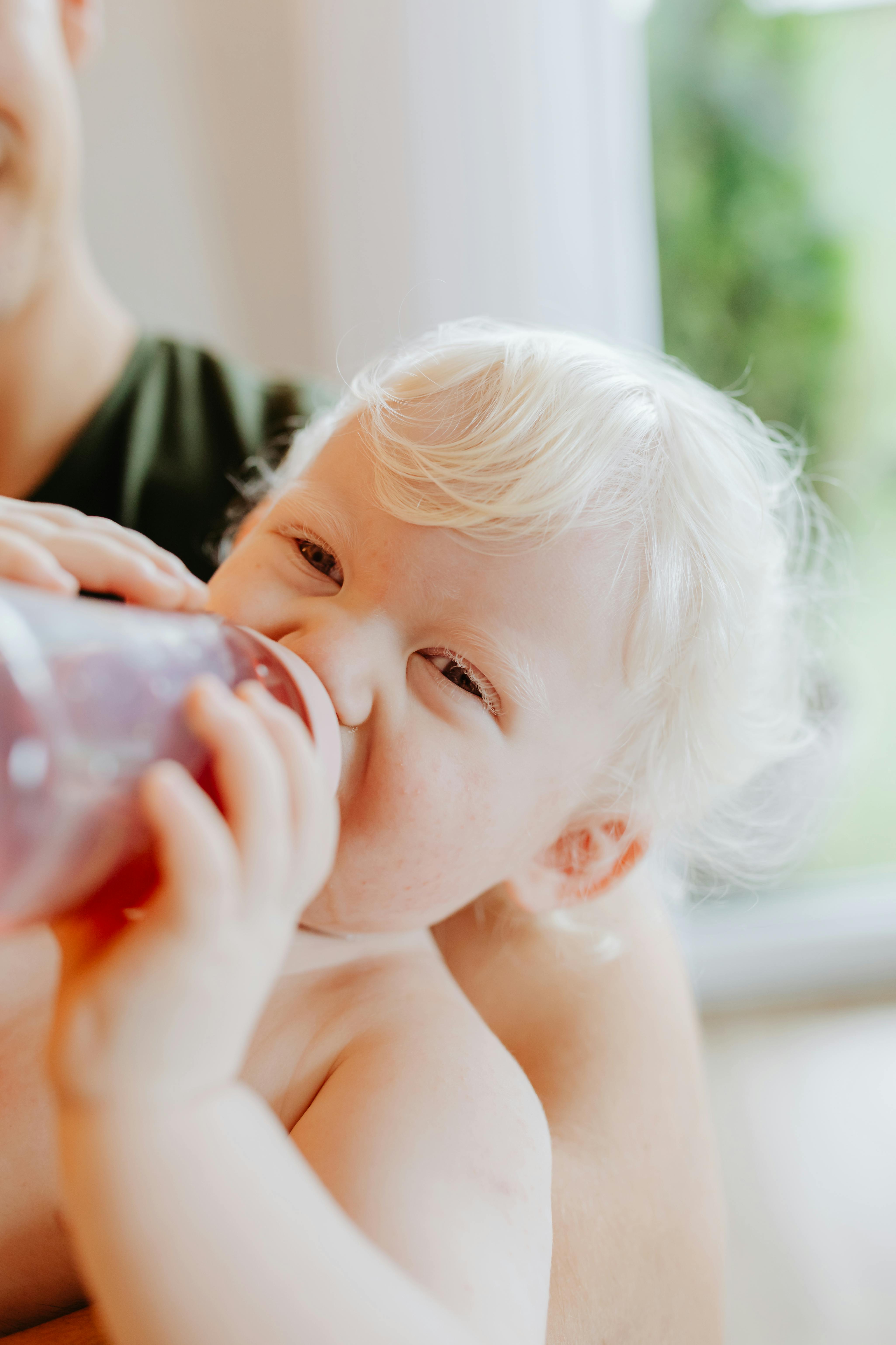 Blonde Baby Drinking from Bottle · Free Stock Photo