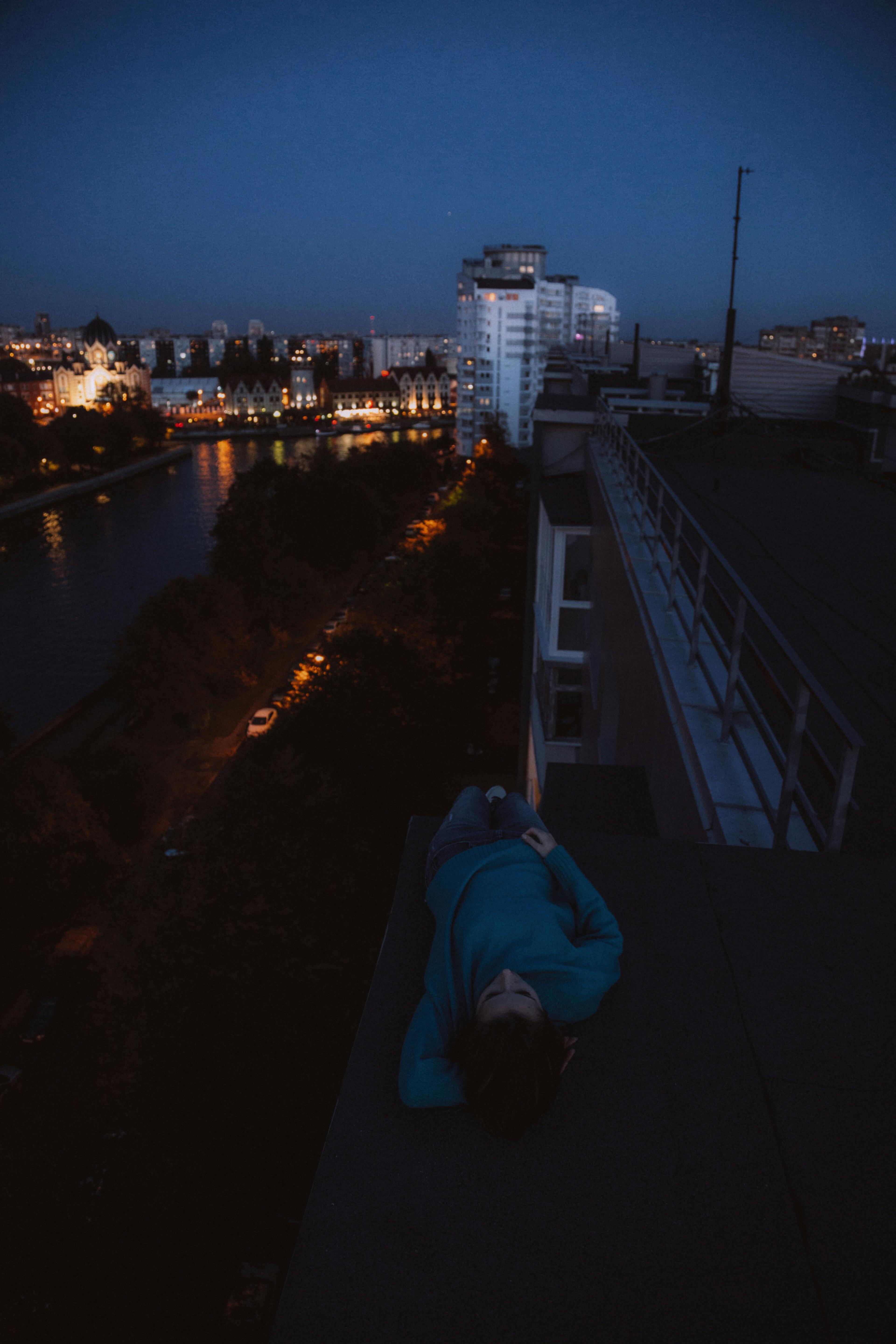 Woman Relaxing on Rooftop Overlooking City at Night · Free Stock Photo