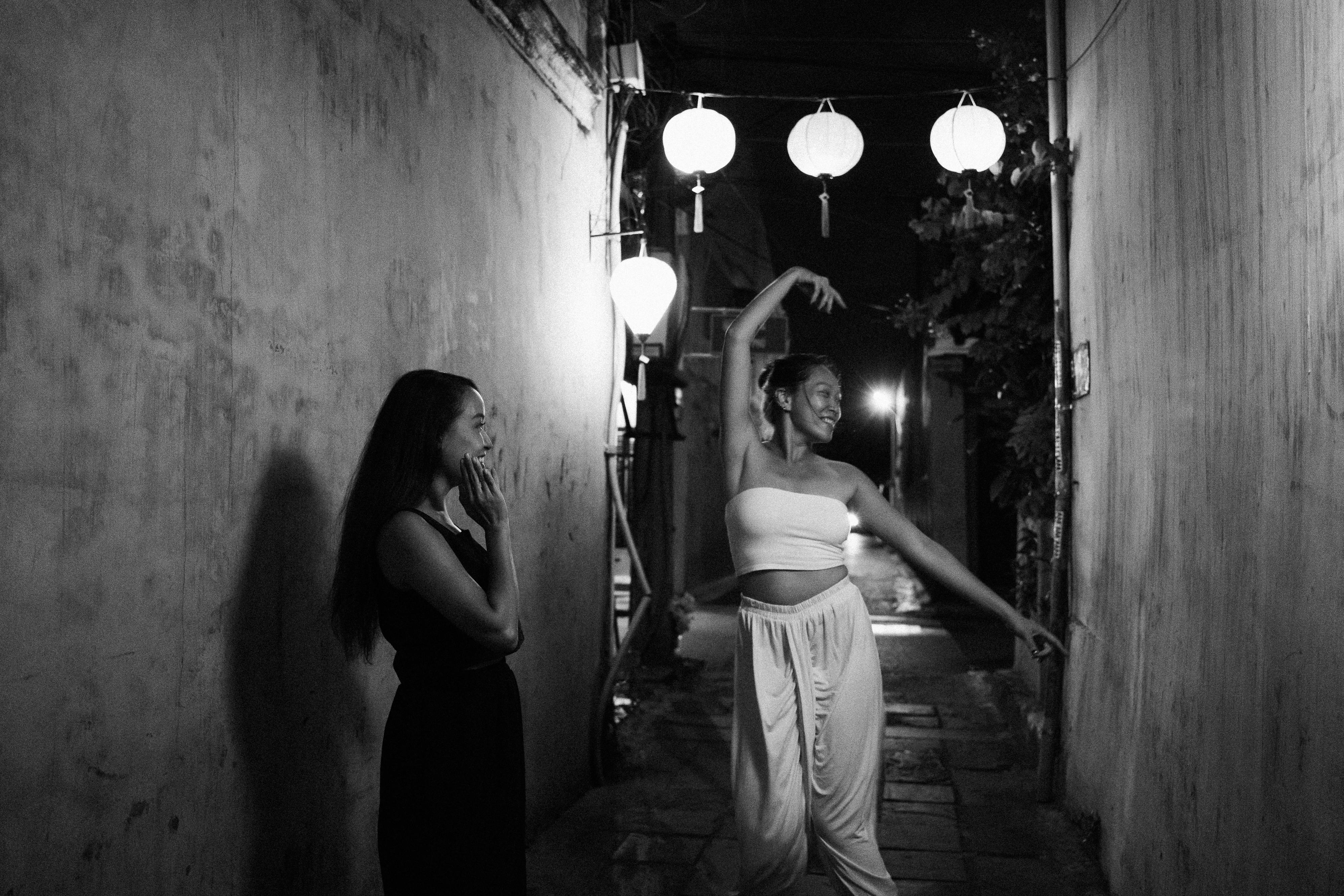 A Woman in White Tank Top Dancing on the Street in Grayscale ...